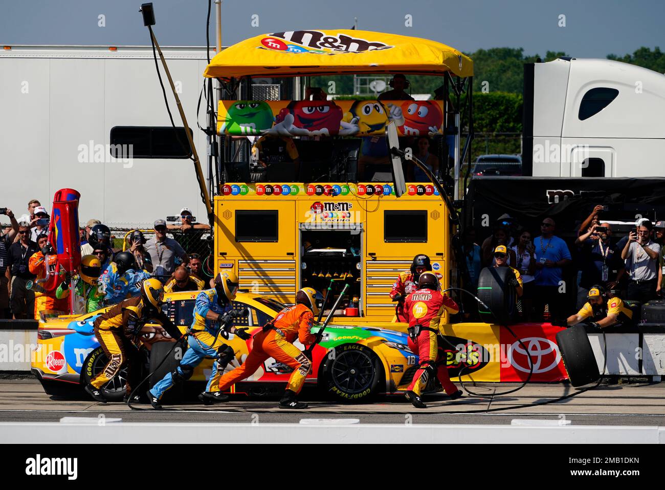 The pit crew for Kyle Busch services the car in a stop during a NASCAR ...