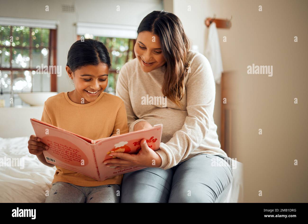 Pregnant mother reading to kid for fun learning, language and home ...