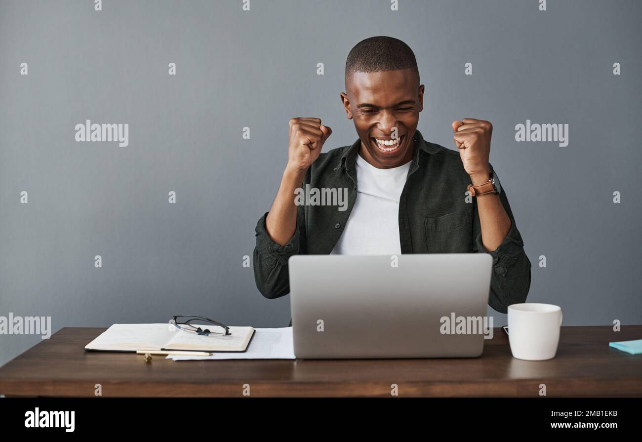 Yes the deal was successful. a young businessman celebrating while ...