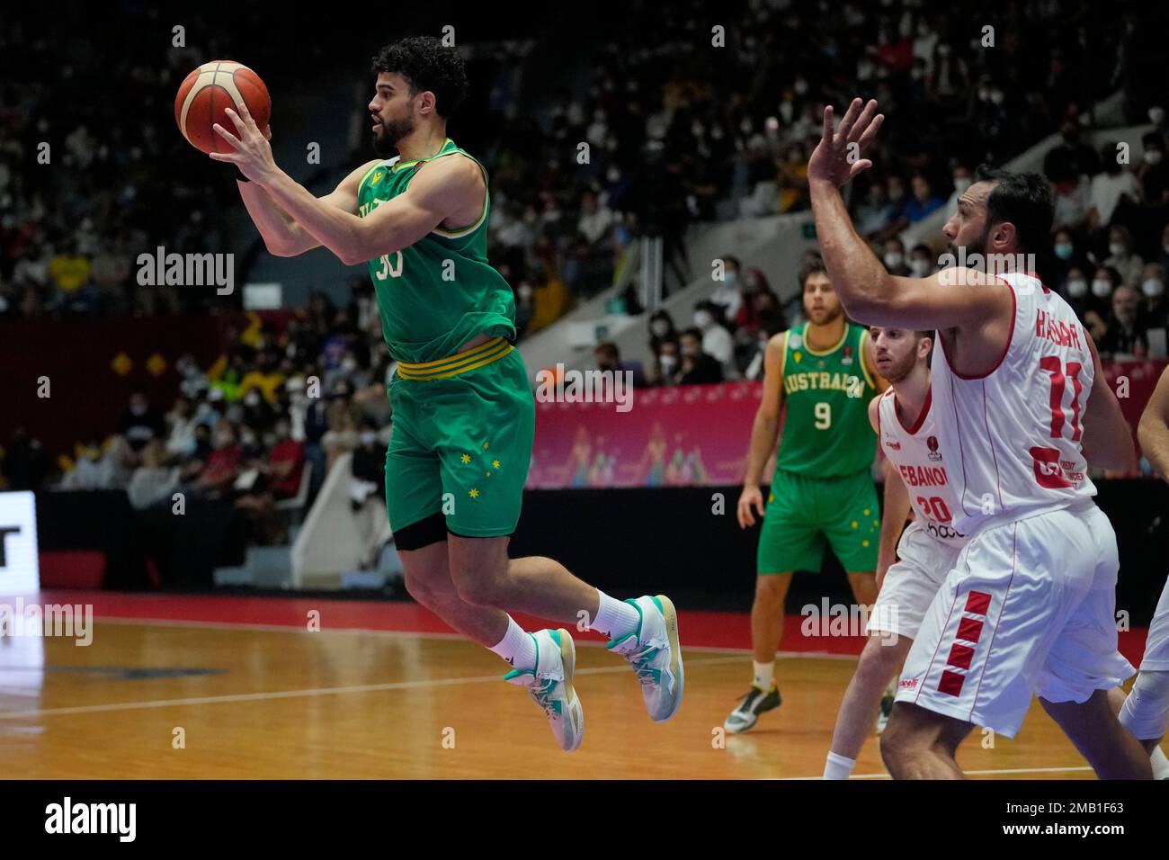 Australia's Samuel McDaniel, left, grabs a rebound against Lebanon's ...