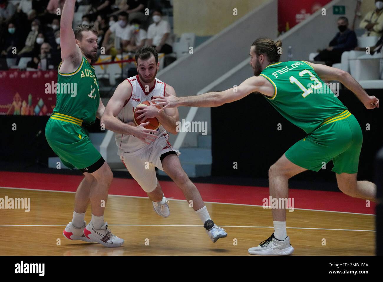 Lebanon's Wael Arakji, center, drives past Australia's Samson James ...
