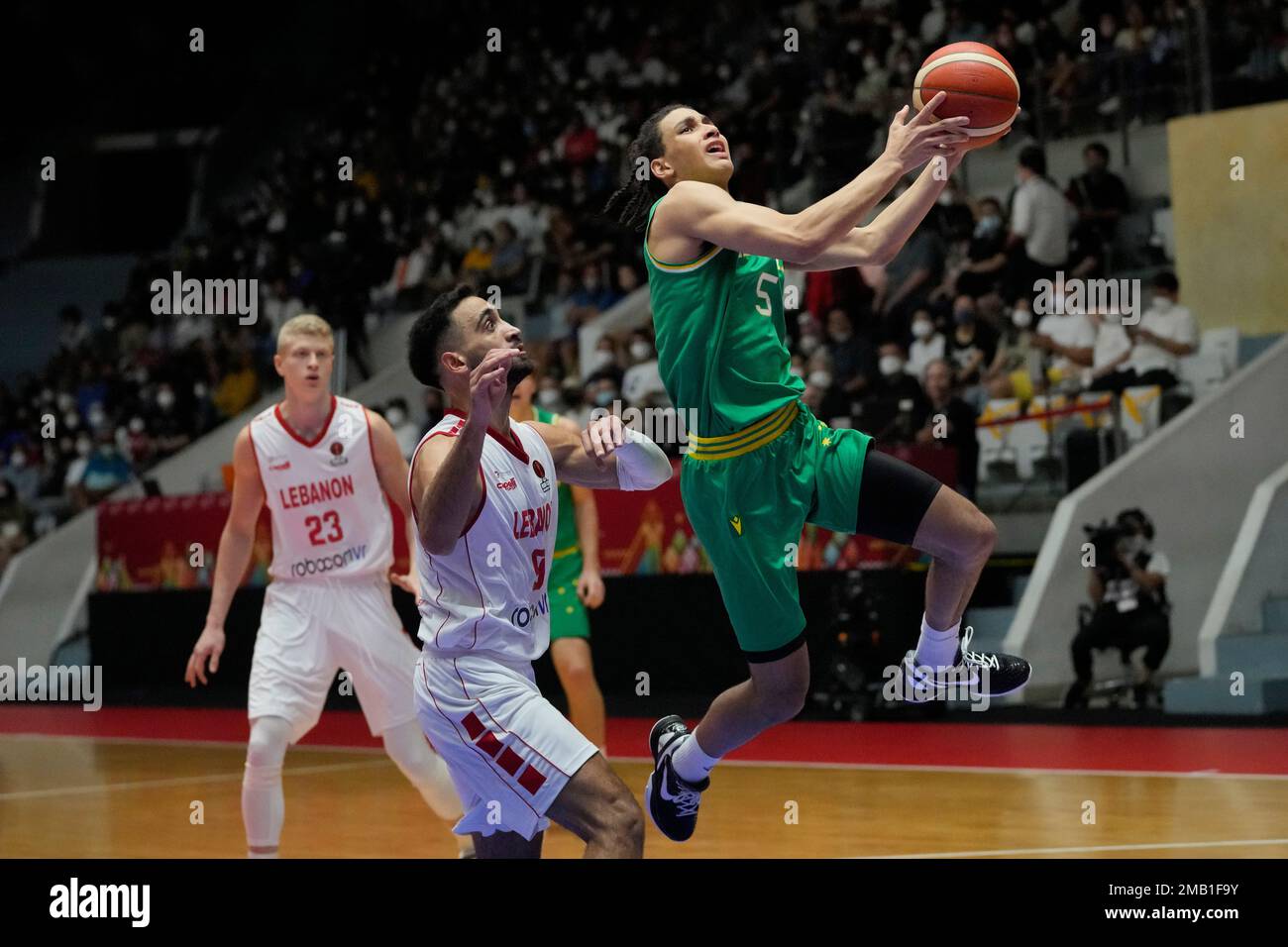 Australia's Tyrese Proctor, right, makes a lay up against Lebanon's ...