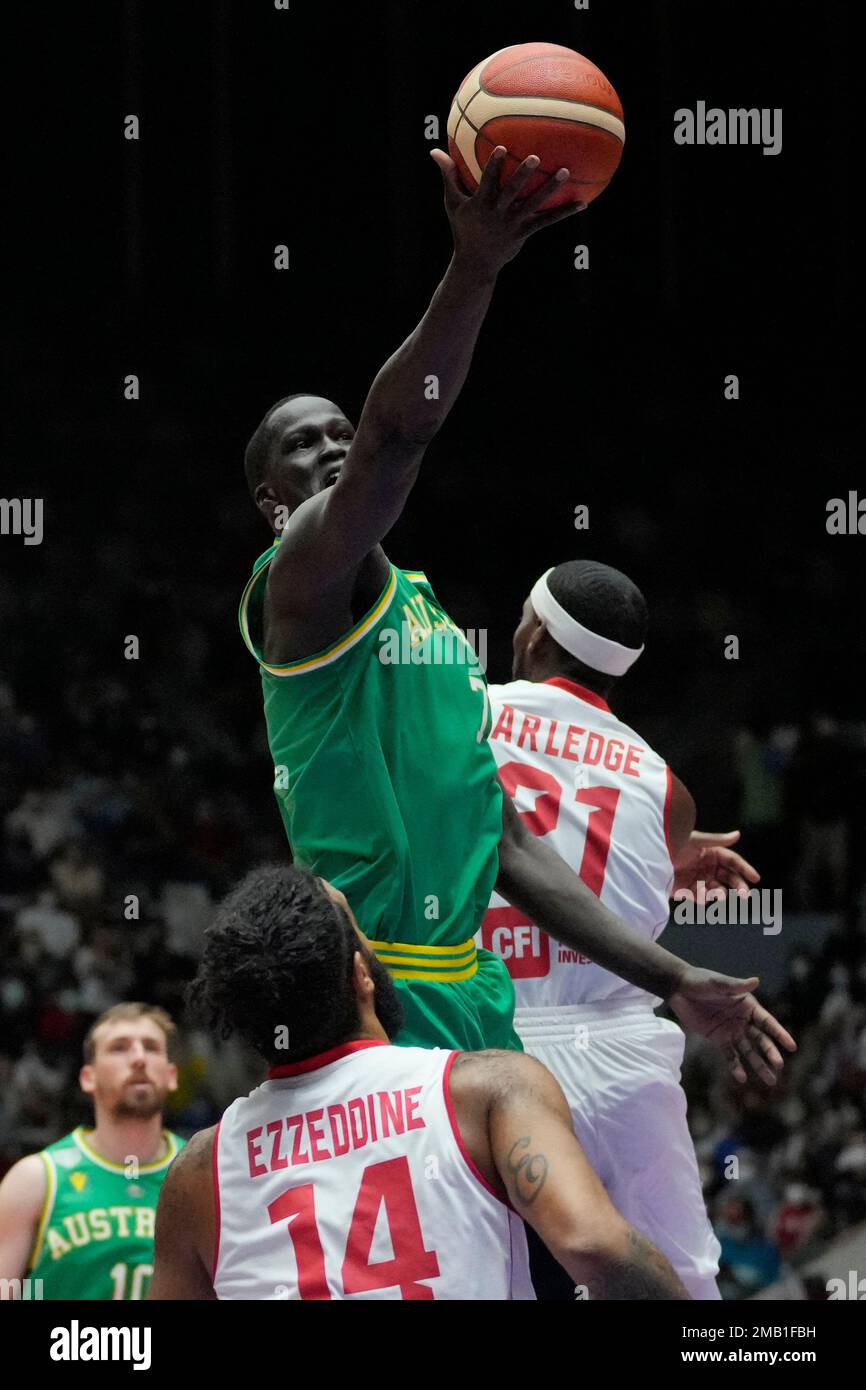 Australia's Thon Maker, center, shoots over Lebanon's Karim Raphael ...