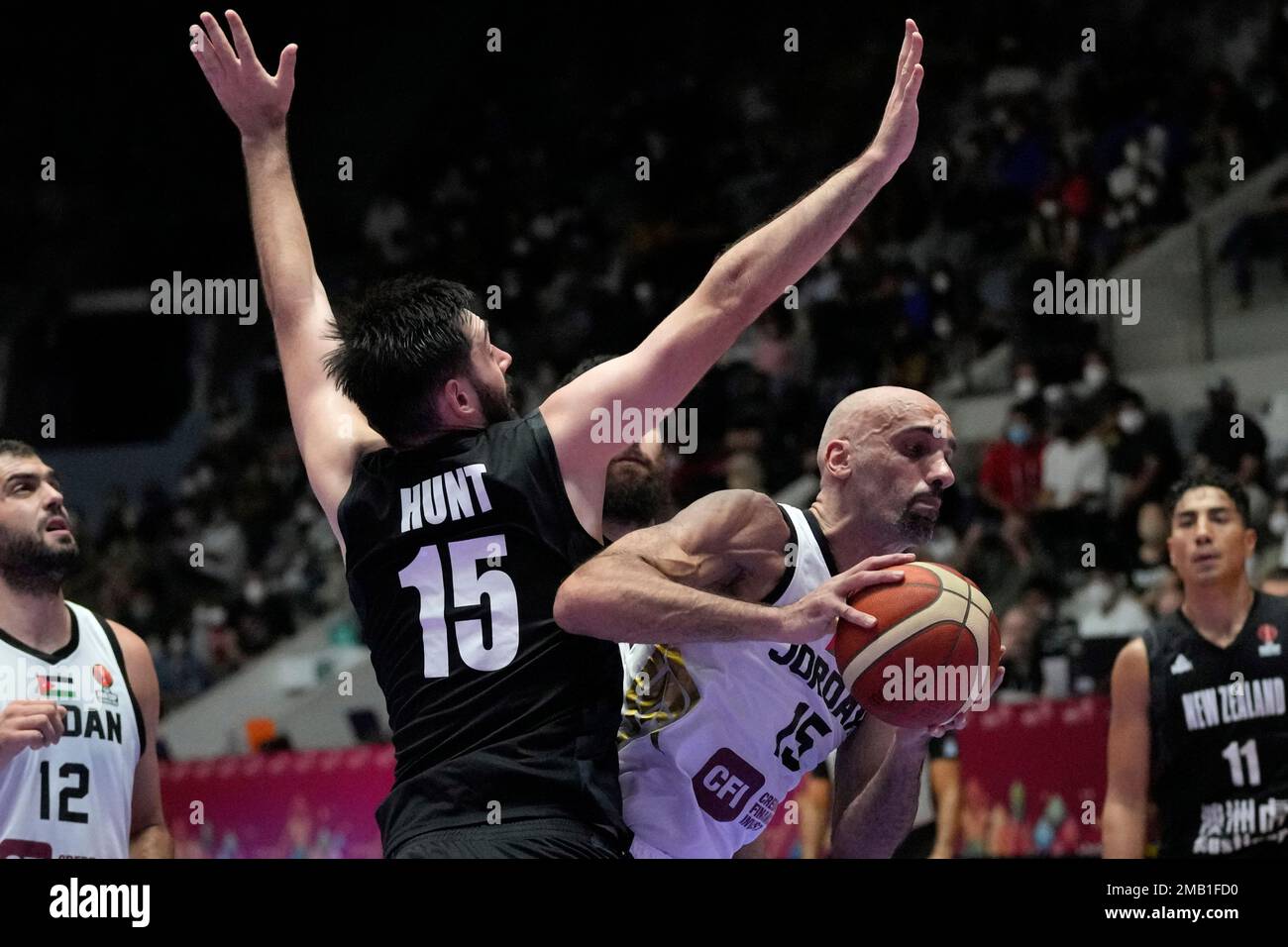 Jordan's Zaid Abbas, right, drives against New Zealand's Jordan Hunt ...