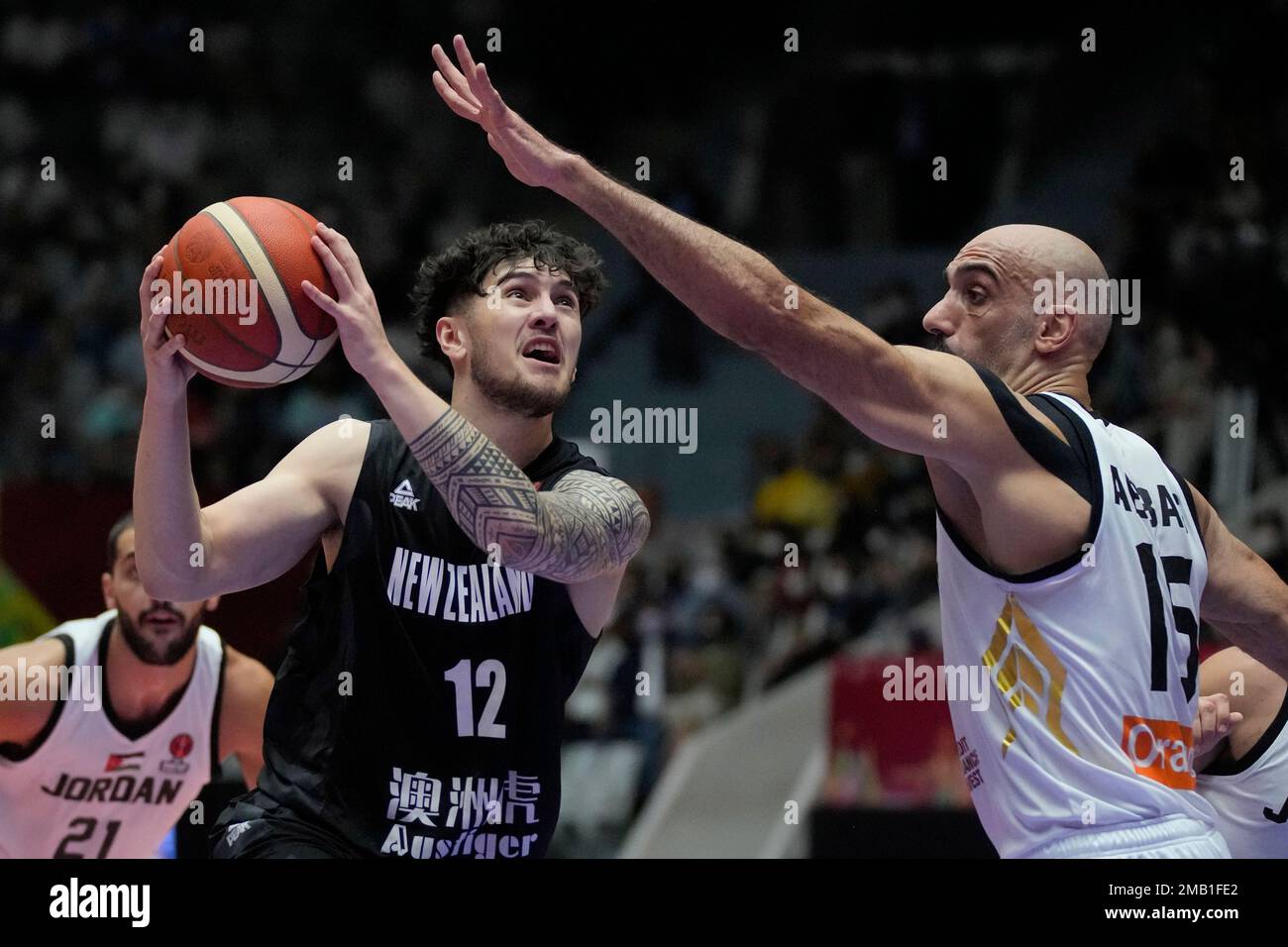 New Zealand's Kruz Perrott-Hunt,l eft, shoots against Jordan's Zaid ...