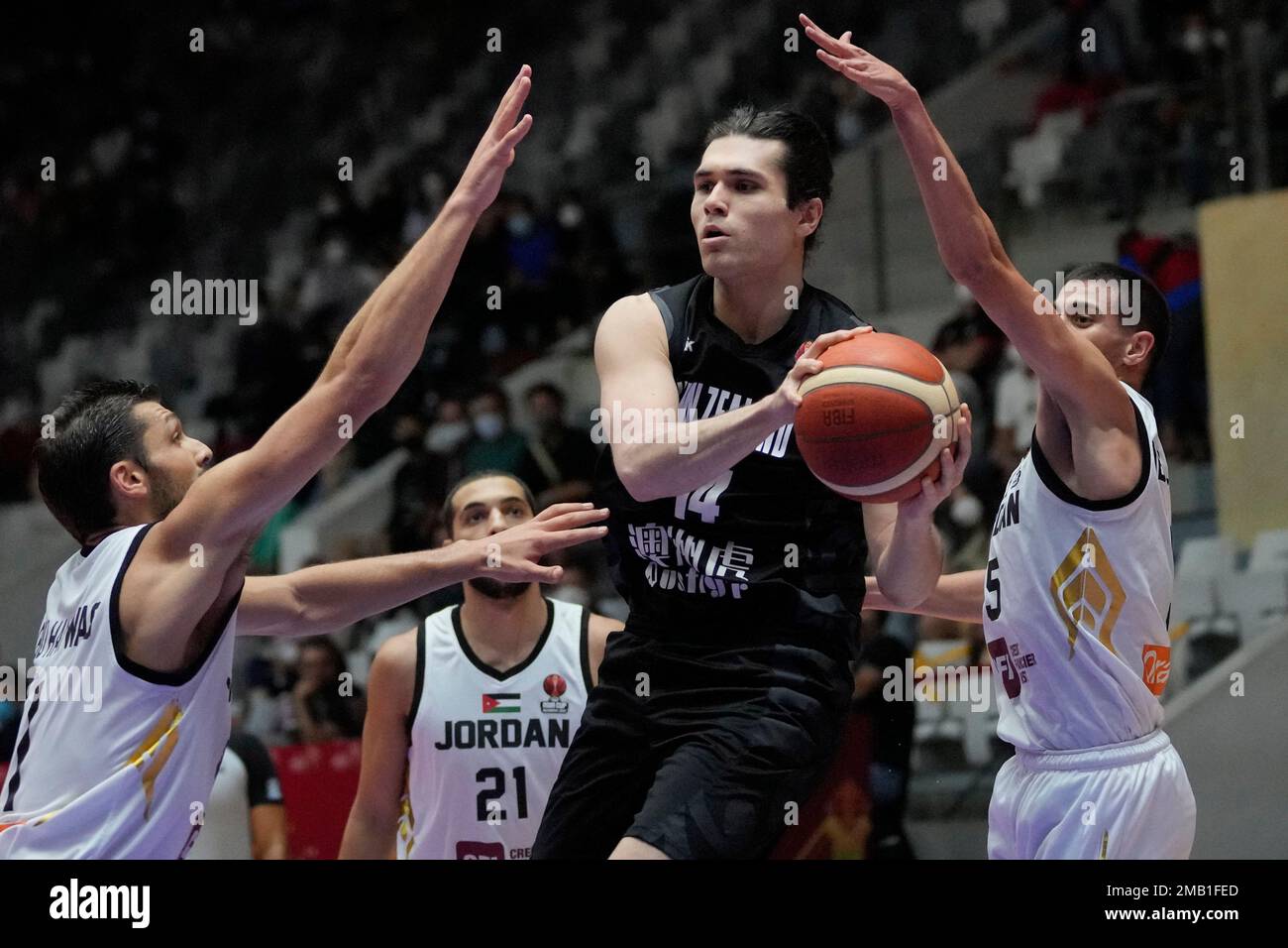 New Zealand's Isaac Davidson, center, drives past Jordan's Amin Abu ...