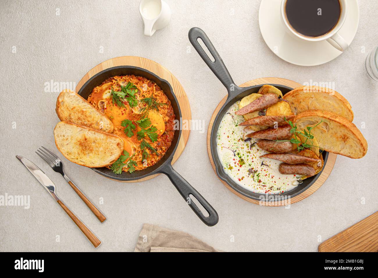 Two pan dishes with sausages and eggs Stock Photo - Alamy