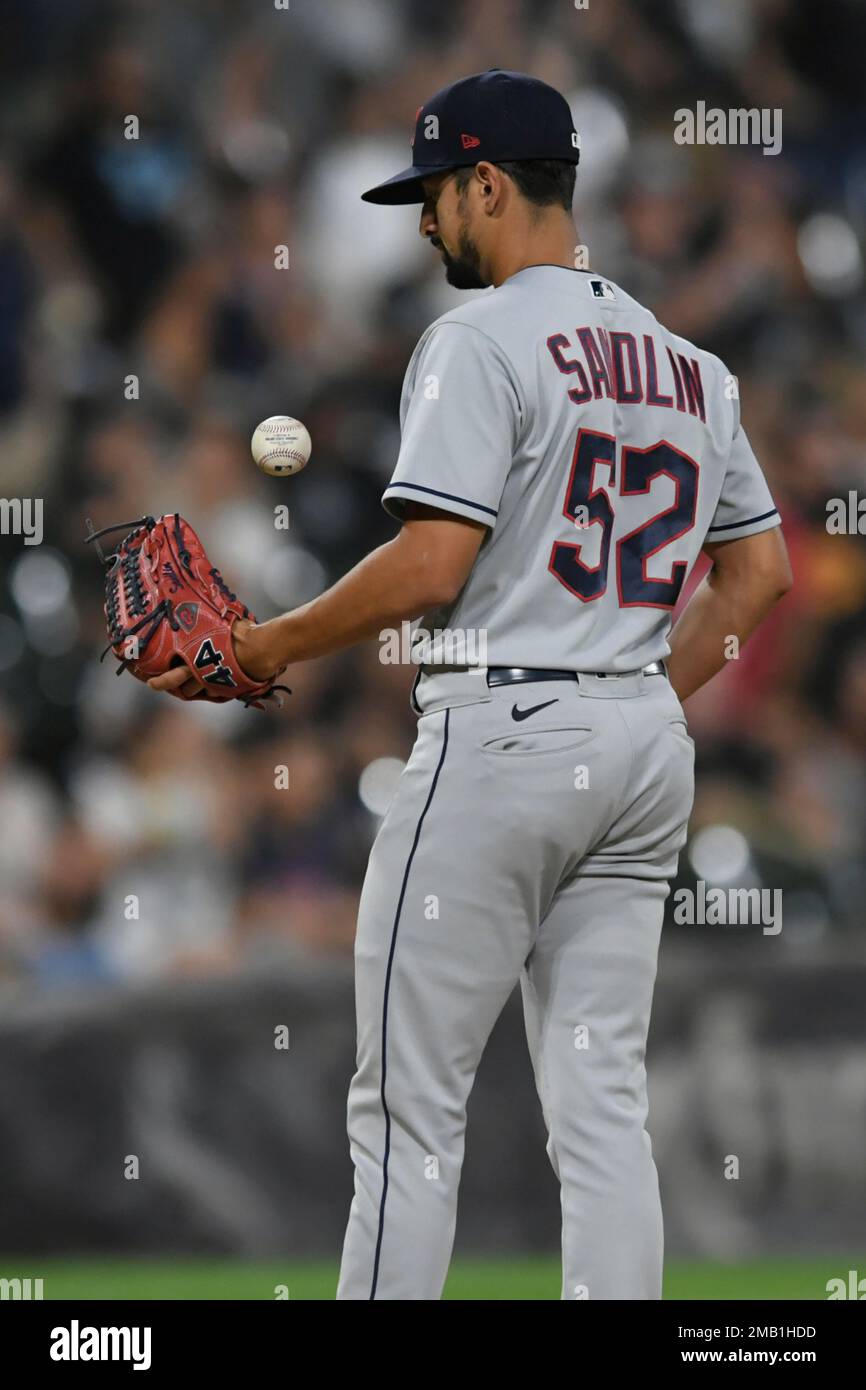 Cleveland Guardians relief pitcher Nick Sandlin reacts after giving up ...