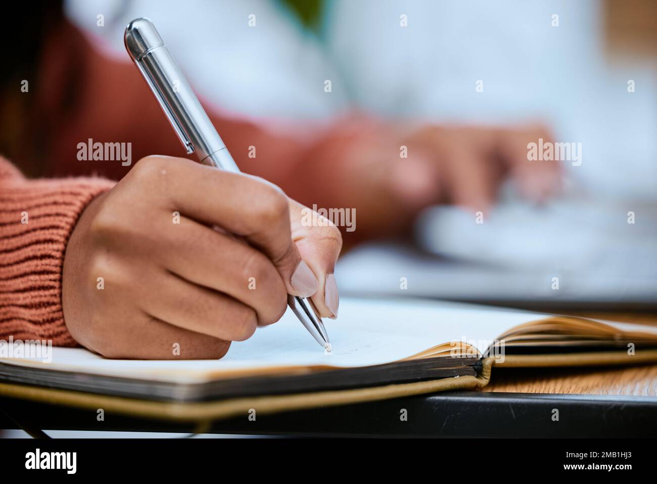 Student, writing and zoom of hand with notebook for studying, learning ...