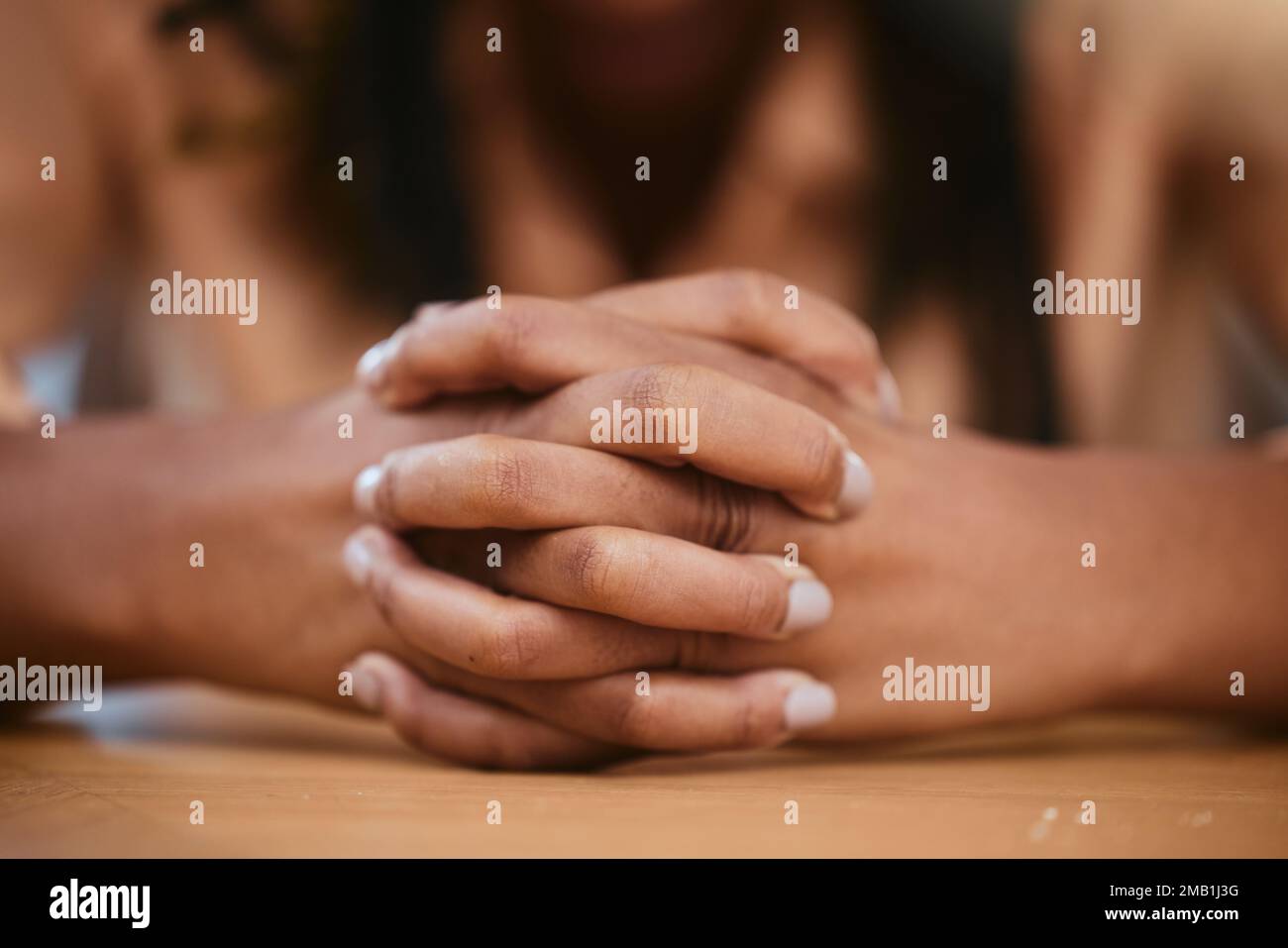 Hands, pray and trust with a black woman asking god for help while praying alone in her home ...