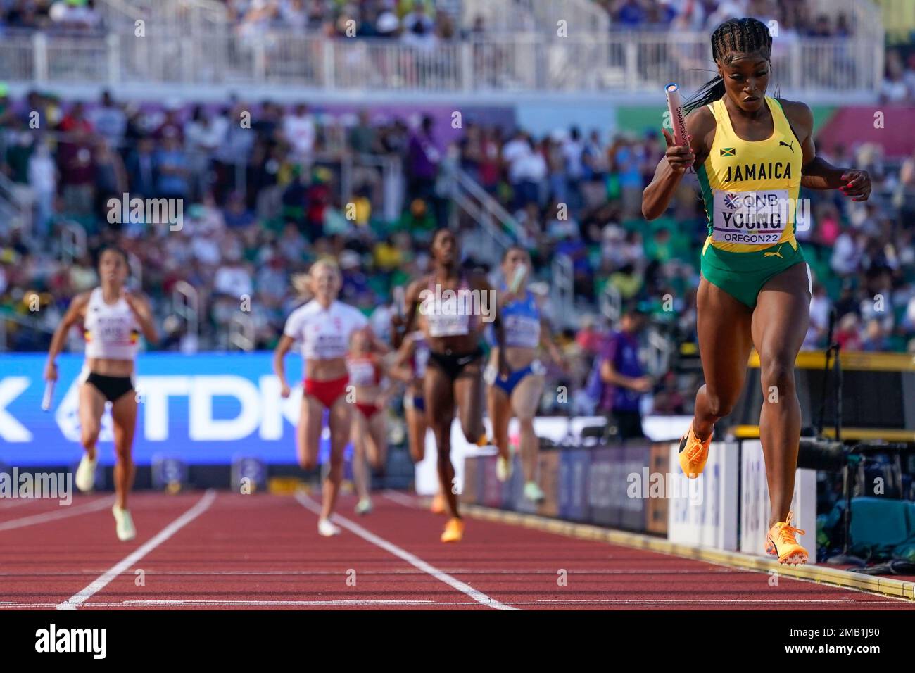 Charokee Young, of Jamaica, wins a heat during the women's 4x400-meter ...