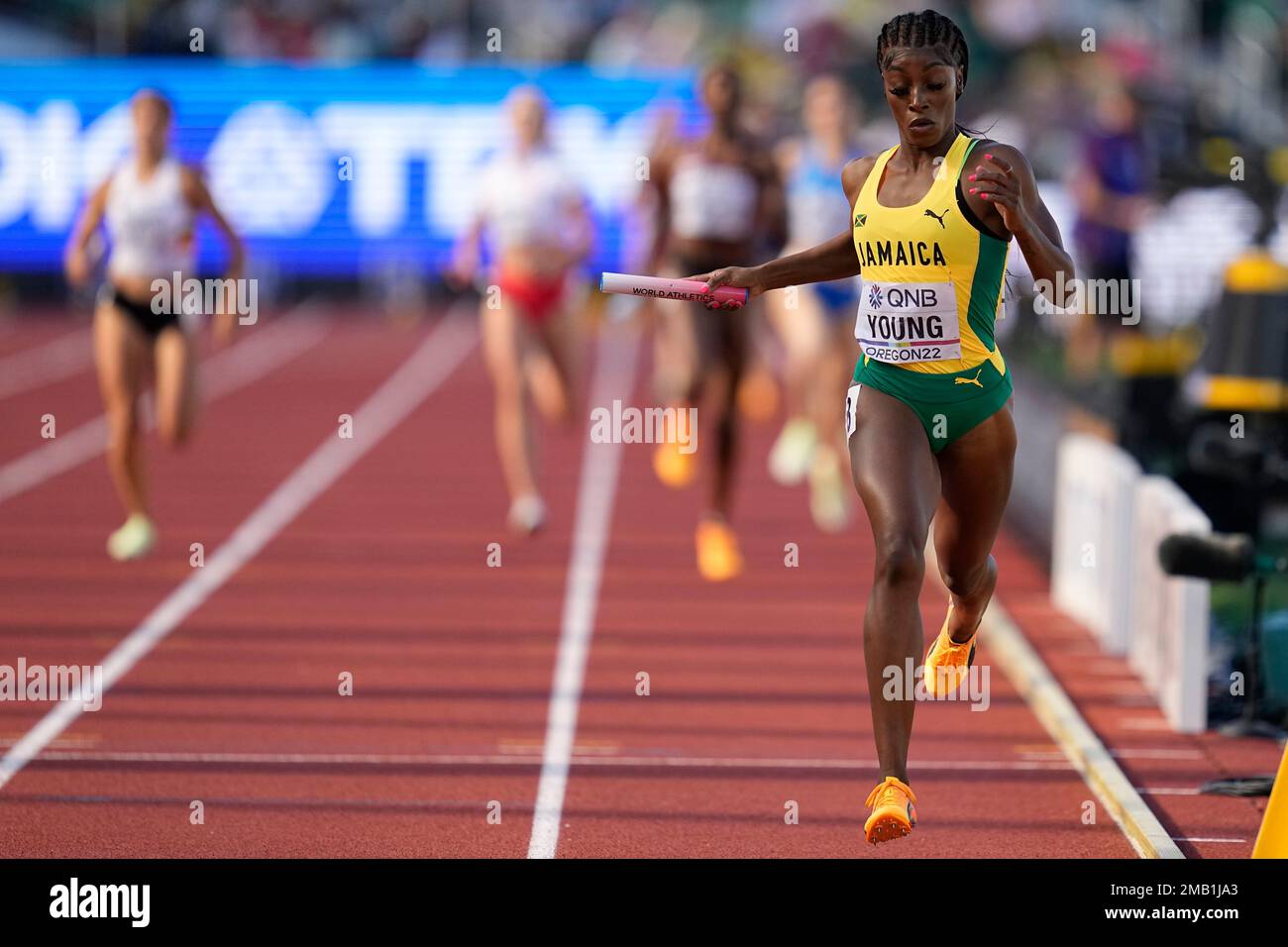 Charokee Young, of Jamaica, wins a heat during the women's 4x400-meter ...