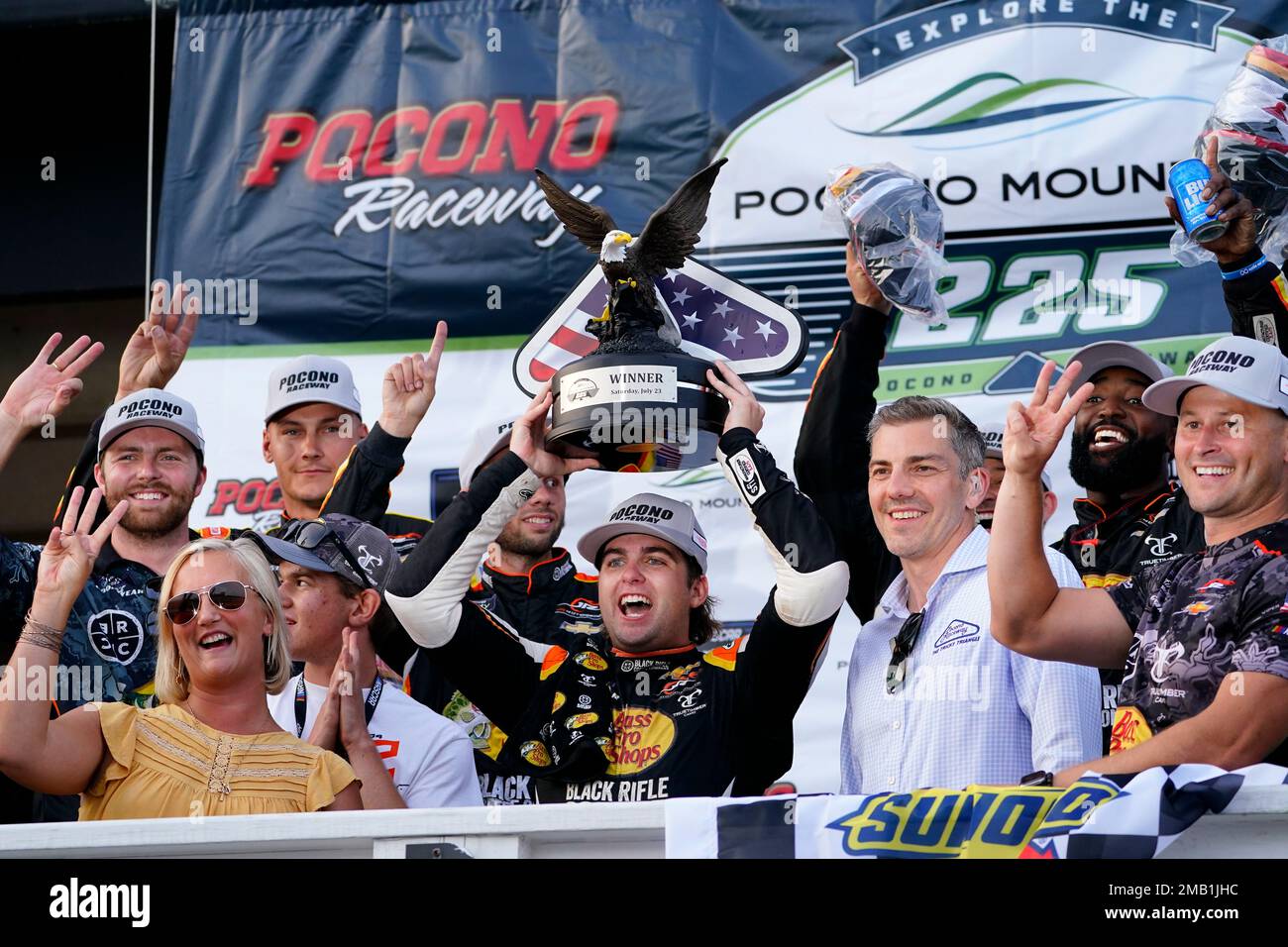 Noah Gragson, center, celebrates with the trophy after he won the ...