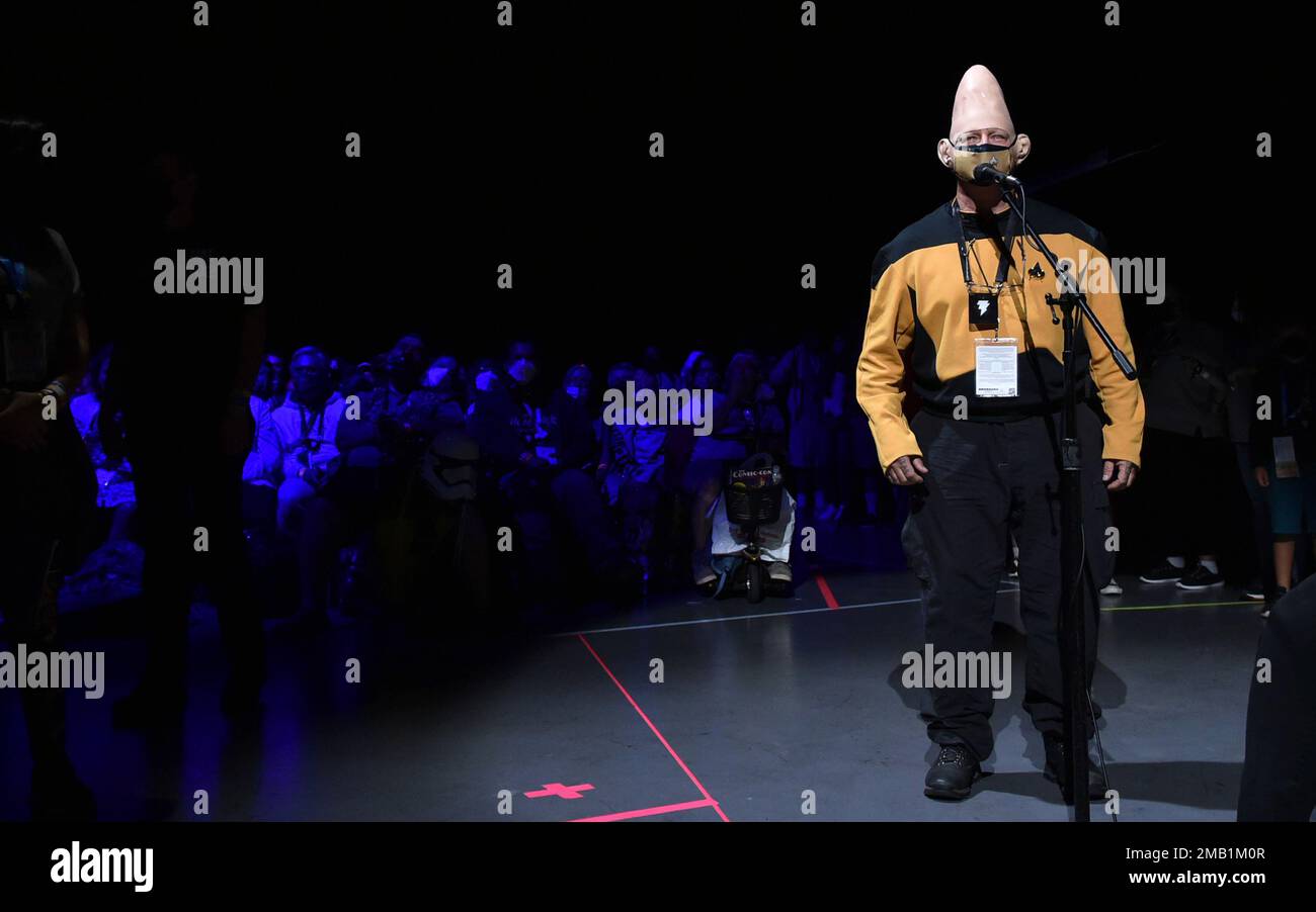 An attendee dressed as a Conehead in Star Trek cosplay asks a question ...
