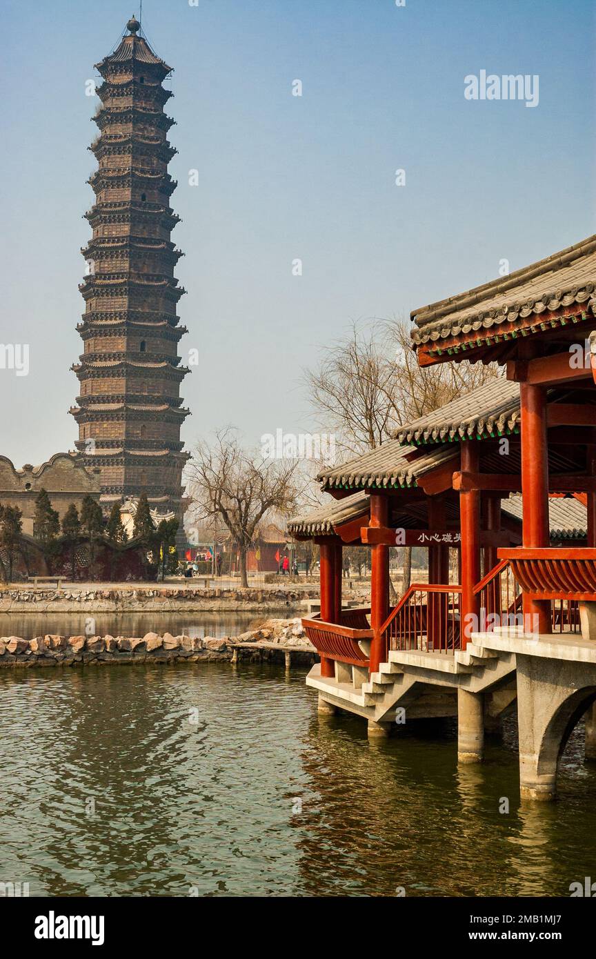 The Iron Pagoda seen from a pond, Kaifeng. Kaifeng was the capital of ...