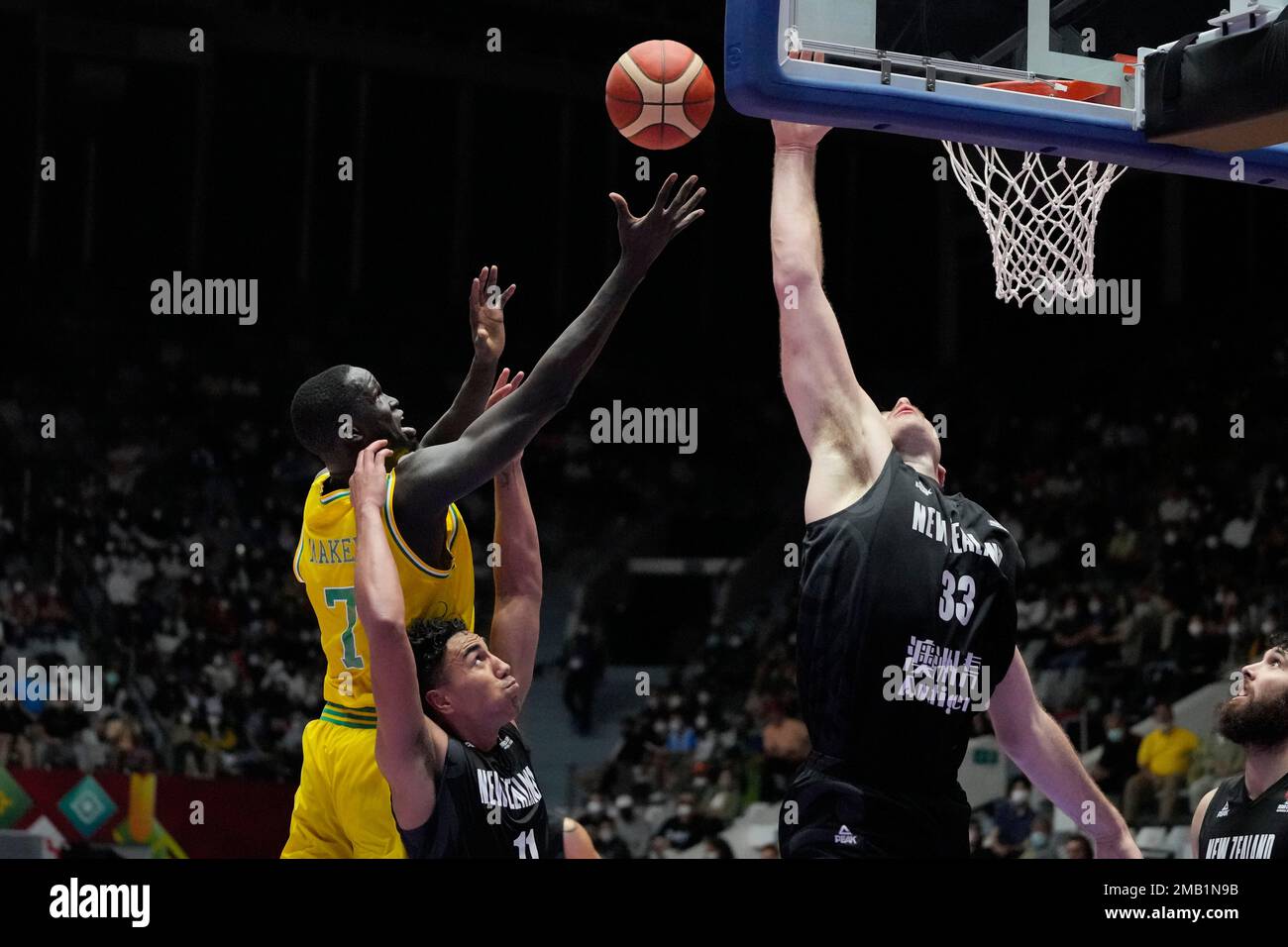 Australia's Thon Maker, left, shoots against New Zealand's Sam Timmins ...