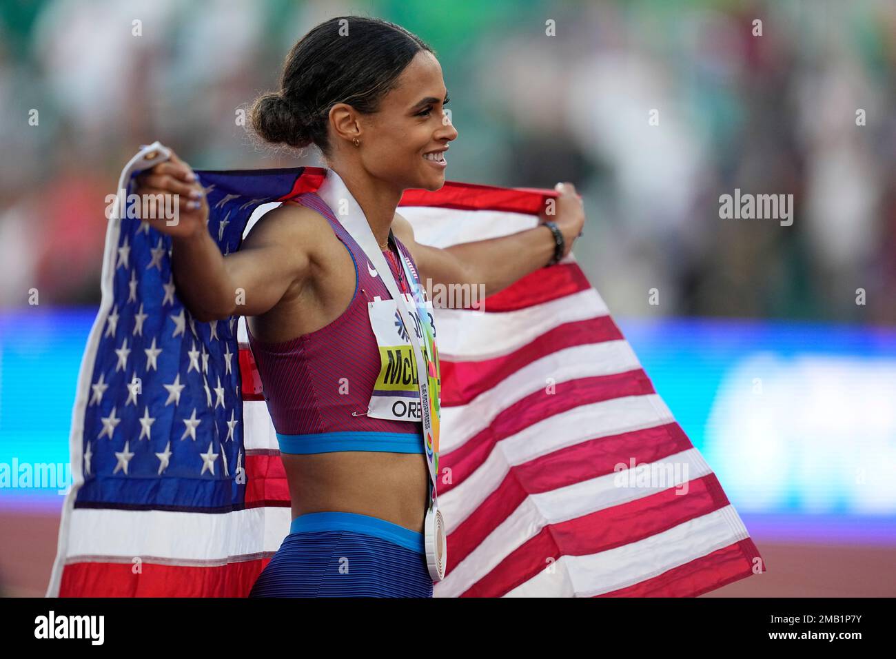 Gold medalist Sydney McLaughlin, of the United States, walks the track ...