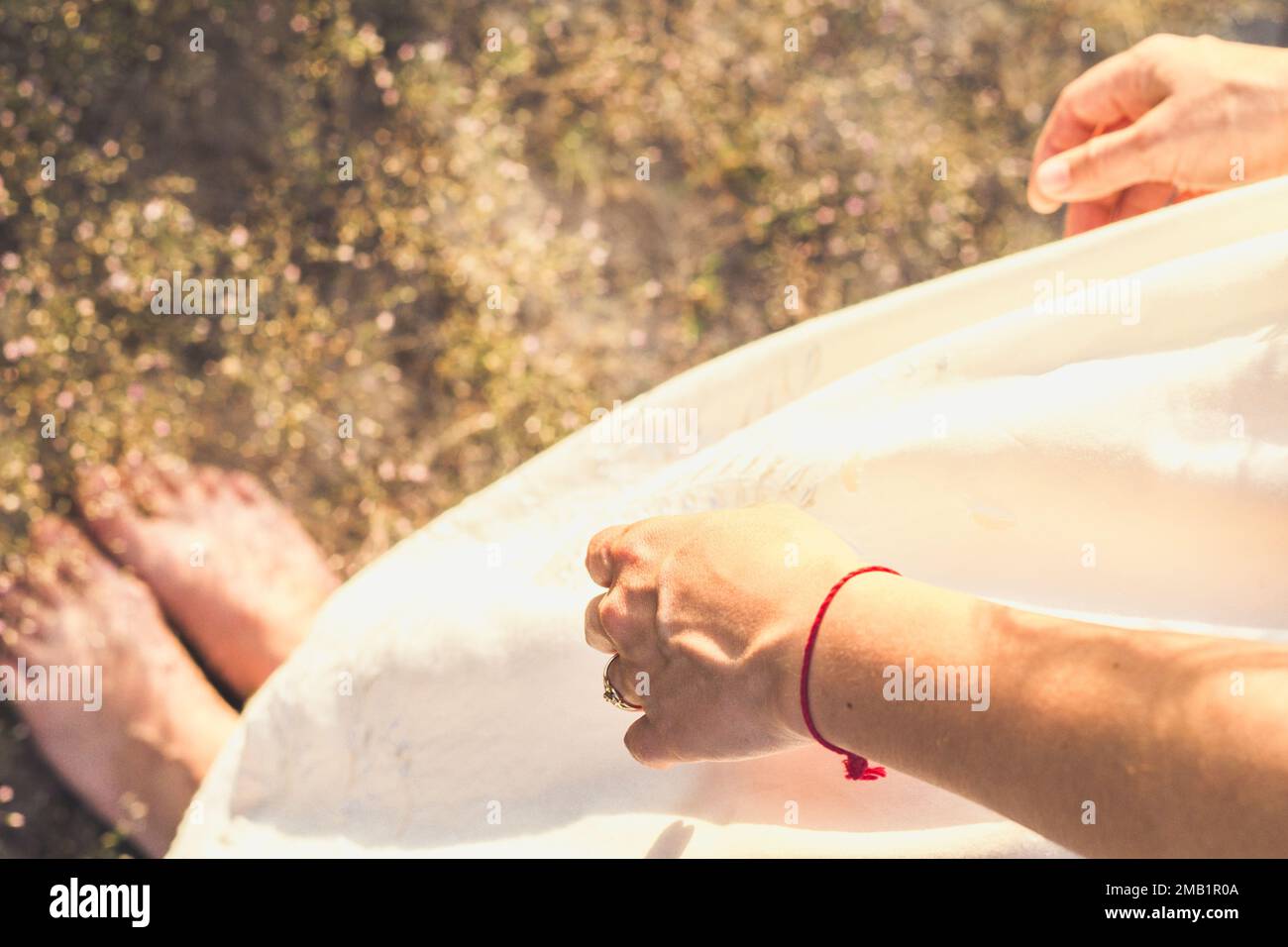 Close up woman in white dress with red thread on wrist concept photo ...