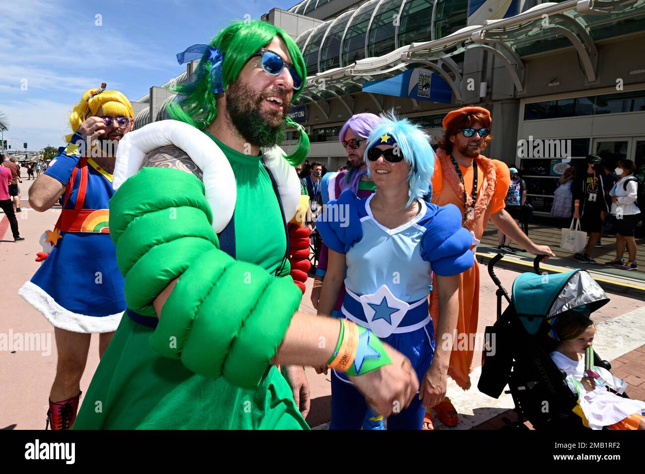 Costumed characters walk in front of the convention center on day two ...