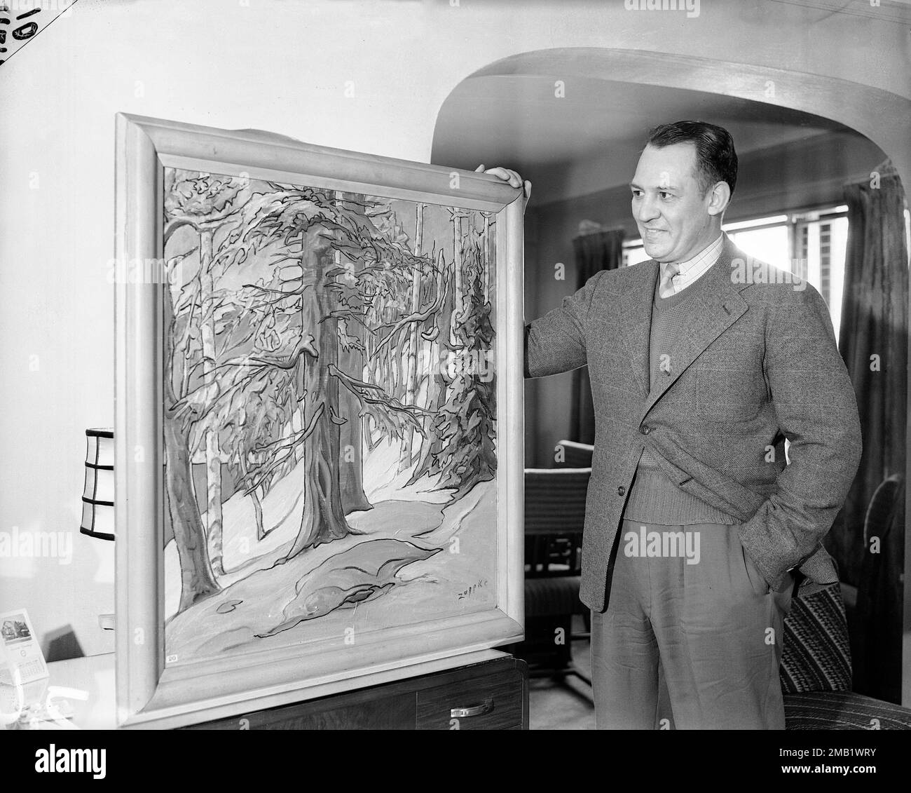 Harold "Red" Grange poses with a painting made by his former University ...