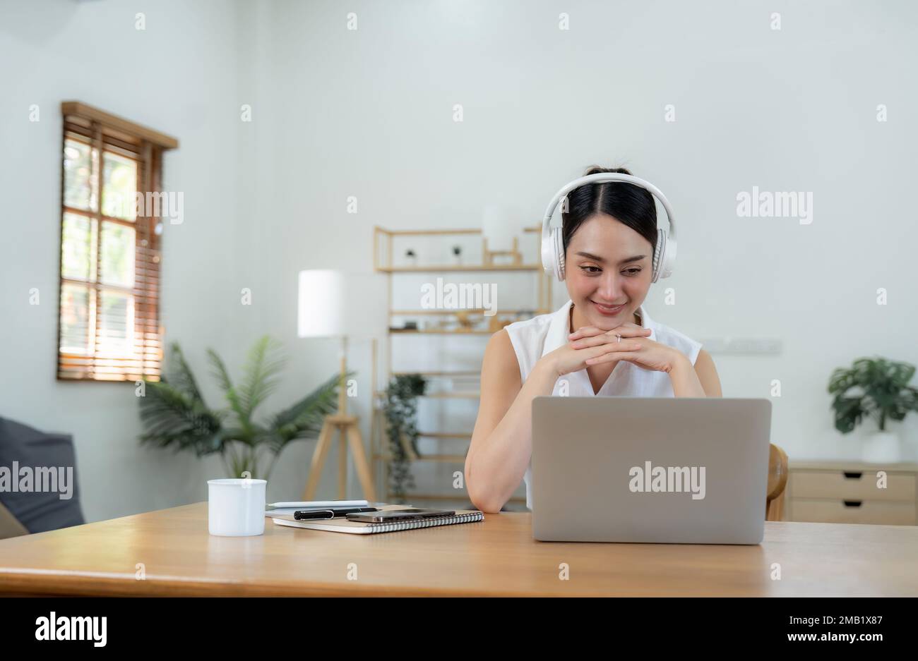 Happy smiling young Business woman with headphone in video call on ...