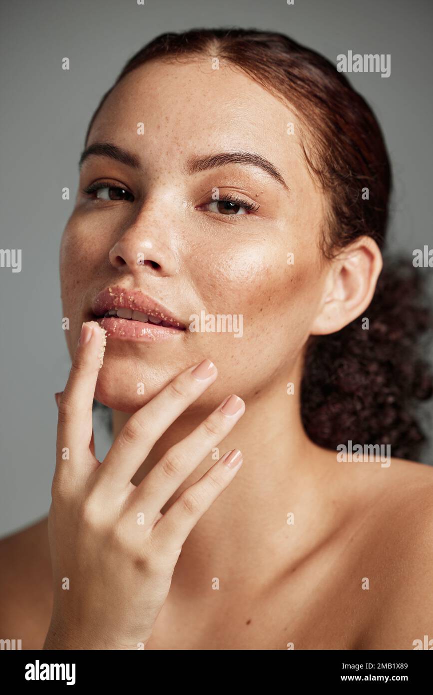 Face, sugar scrub and lips of woman in studio isolated on a gray ...
