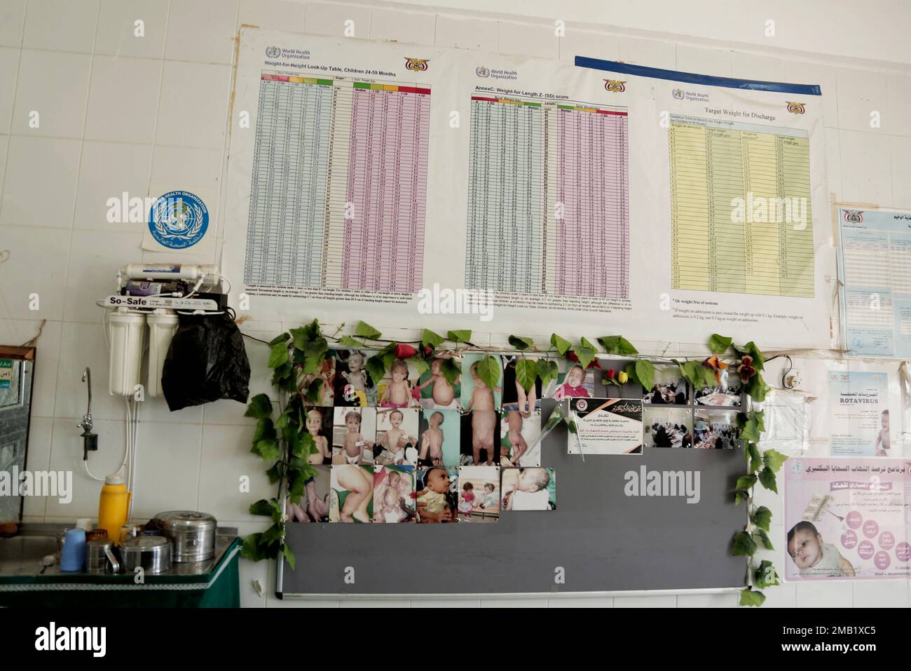 Photographs of severely malnourished infants hung on wall in the ...