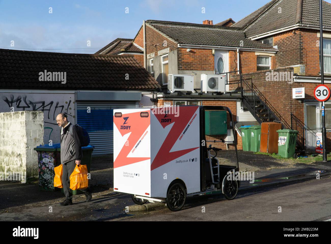 southampton street man walking with orange shopping bags eco pedal ...