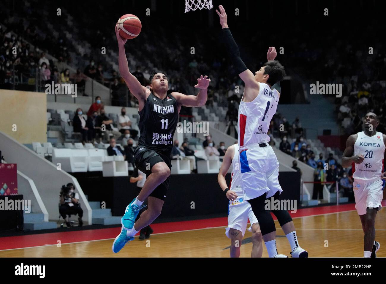 New Zealand's Flynn Cameron, left, shoots against South Korea's Yang ...