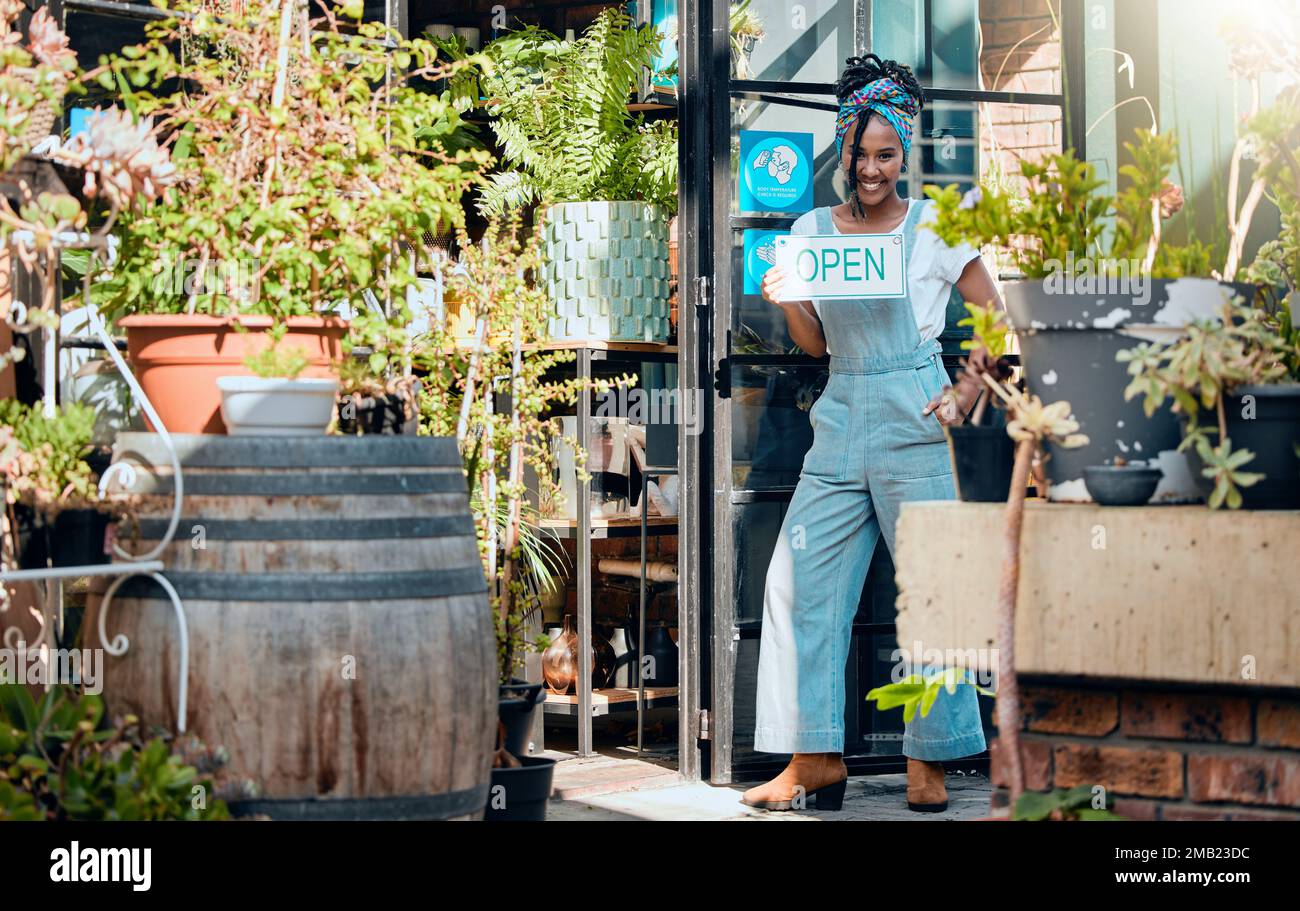 Open sign, small business or black woman in flowers store with ...