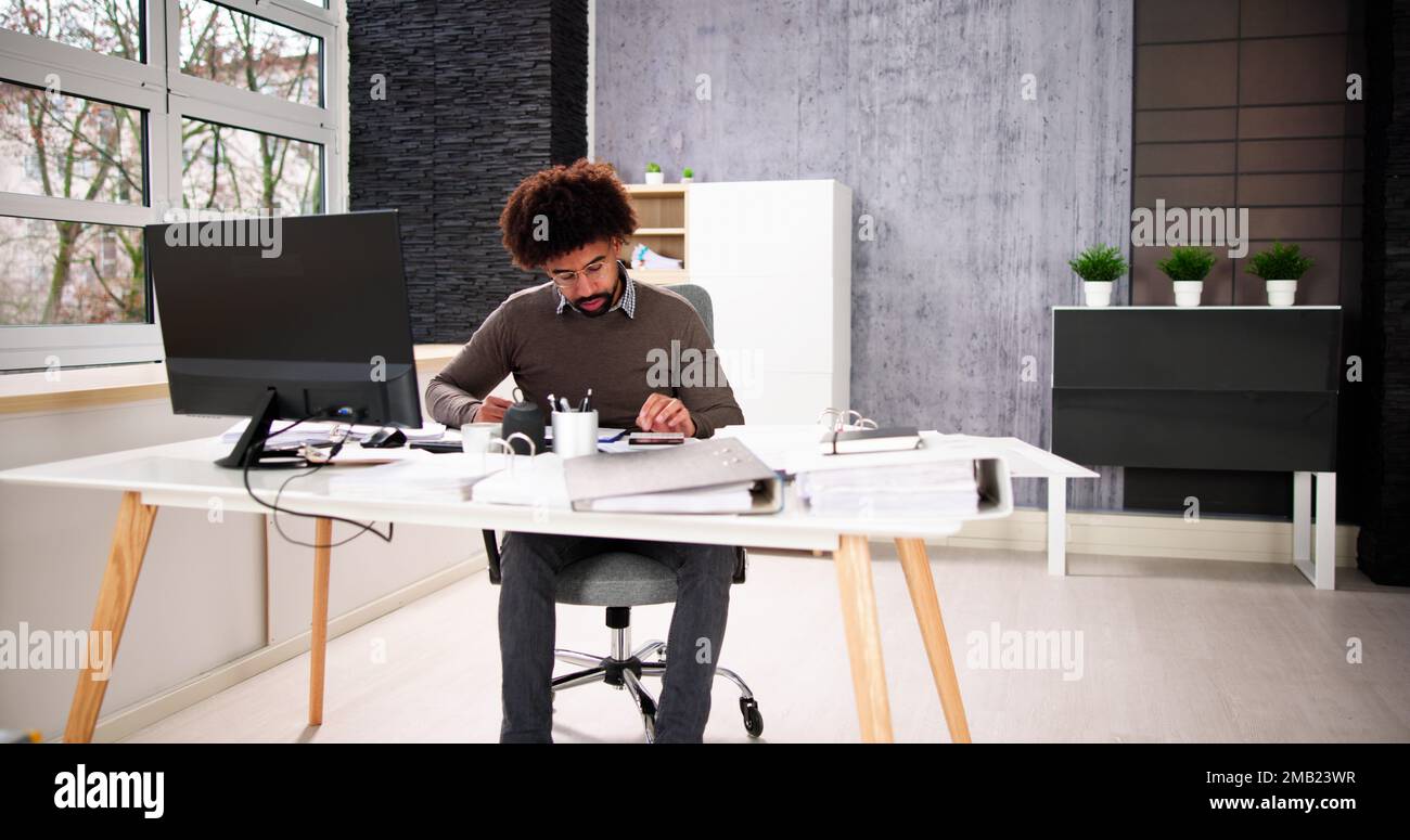 Portrait Of A Accountant Man Calculating Invoice Stock Photo - Alamy