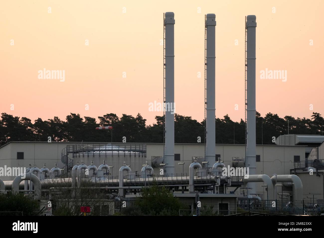 The sun rises behind the landfall facility of the Nord Stream 1 Baltic ...