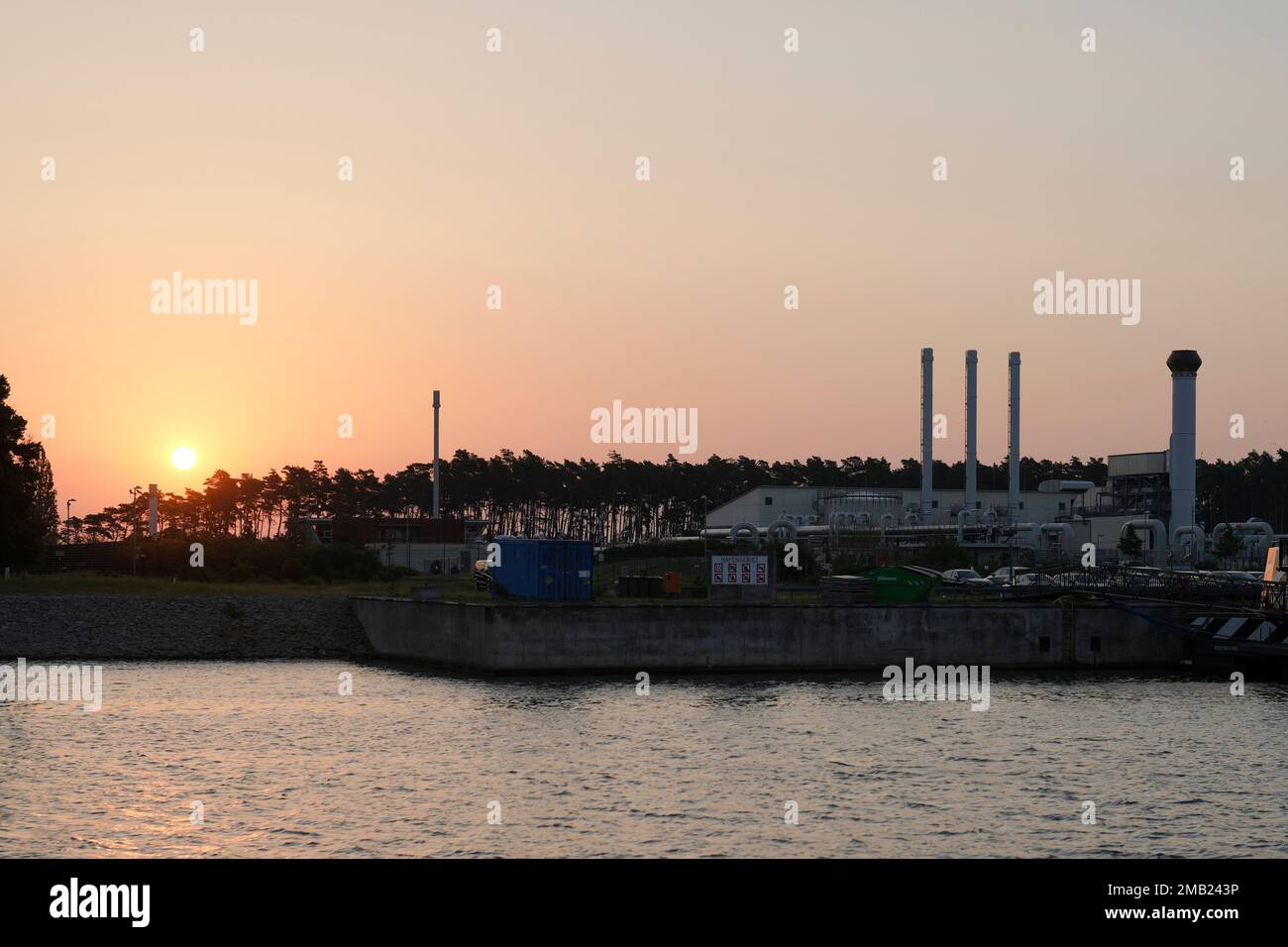 The sun rises behind the landfall of the Nord Stream 1 Baltic Sea ...