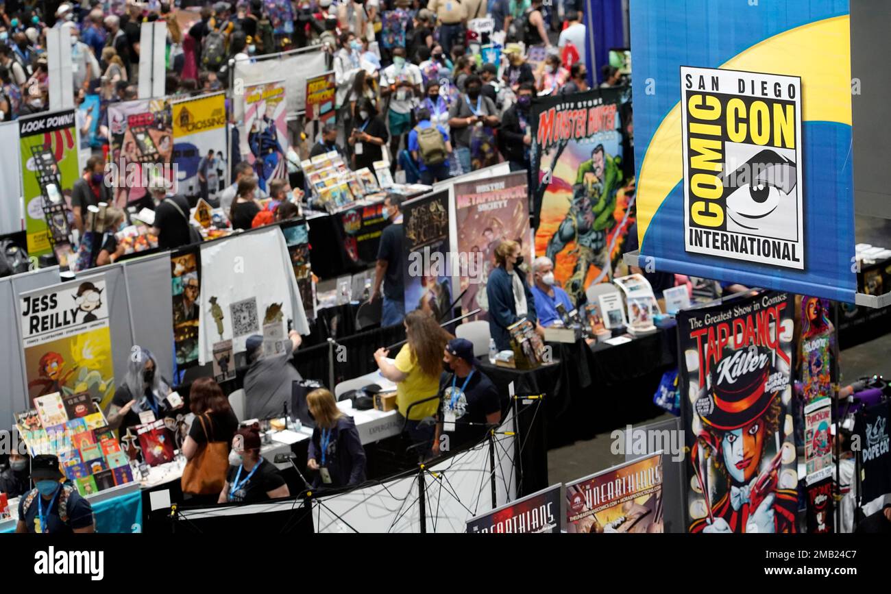 Comic-Con attendees peruse the aisles of the convention show floor ...