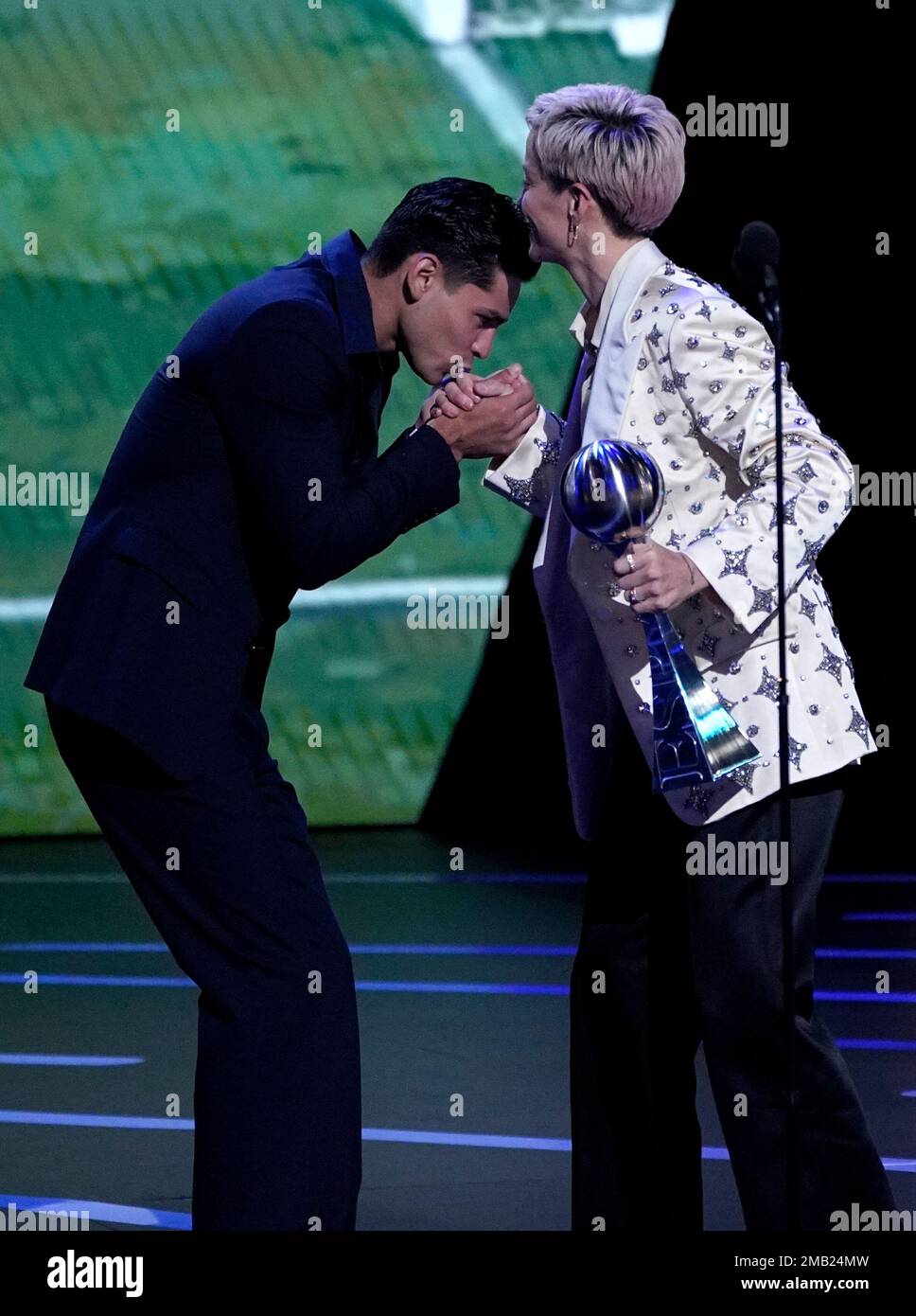 Boxer Ryan Garcia, left, kisses the hand of NWSL player Megan Rapinoe ...