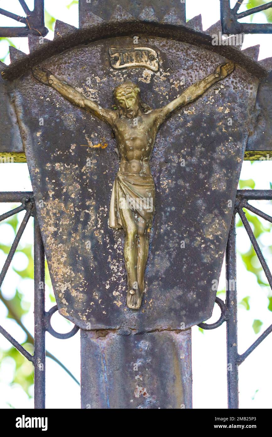 Rusty metal plate with Jesus Christ on old roadside village cross Stock ...