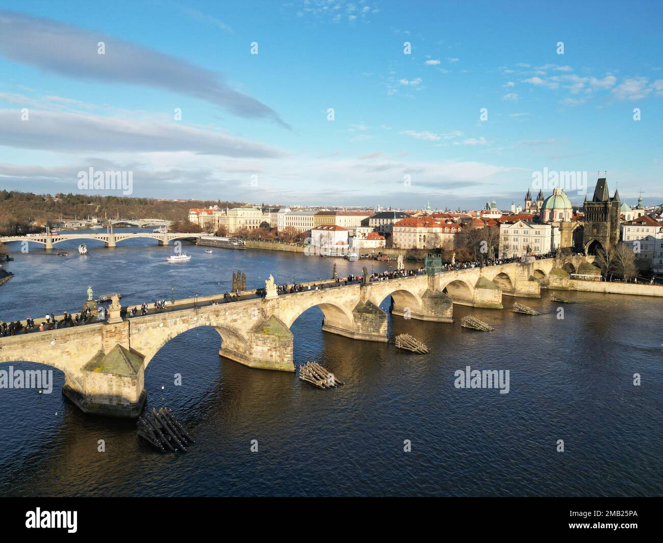 An aerial view of The Charles Bridge over Vltava river surrounded by ...