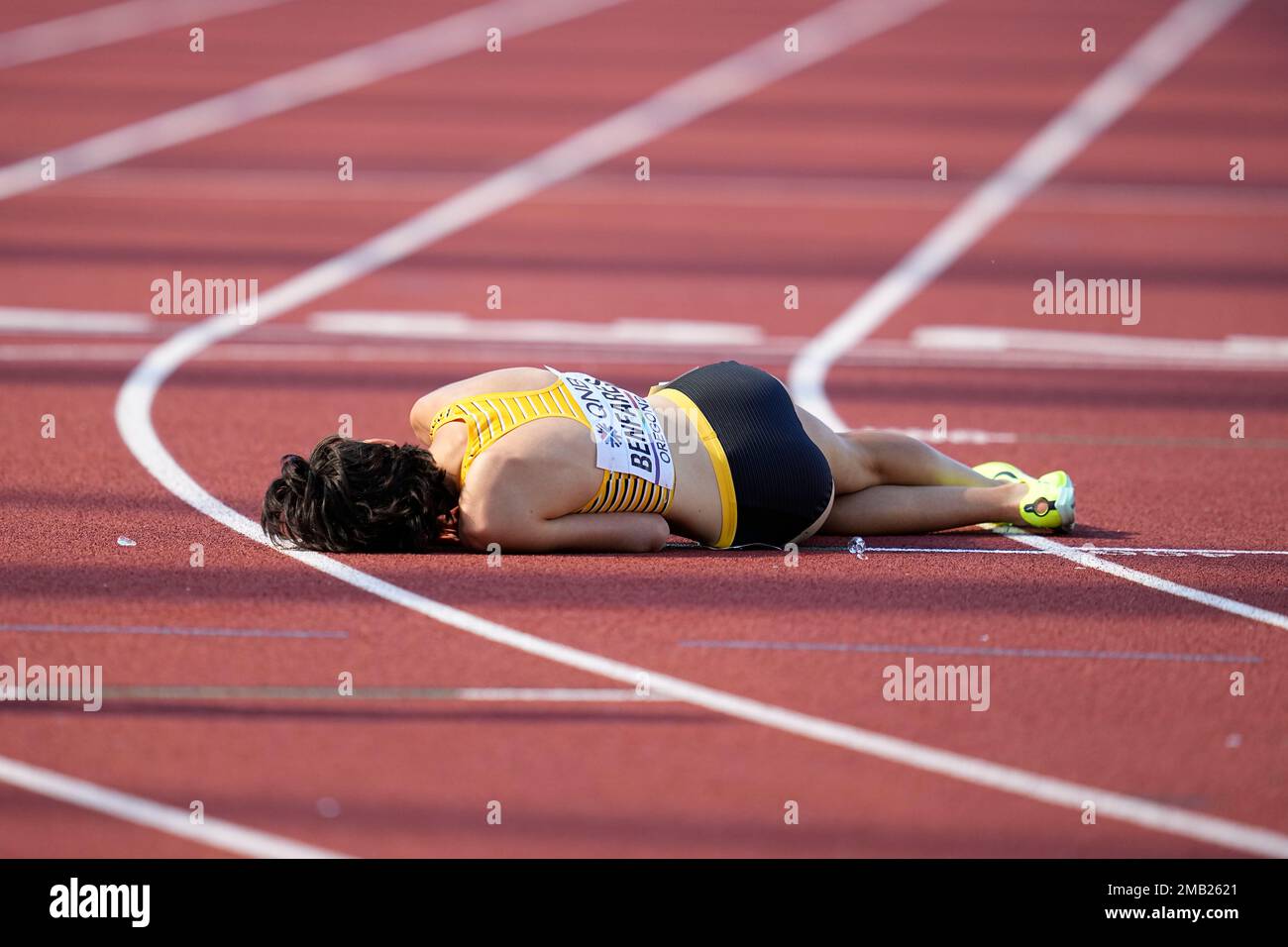 Sara Benfares, of Germany, lies on the track after a heat in the women ...
