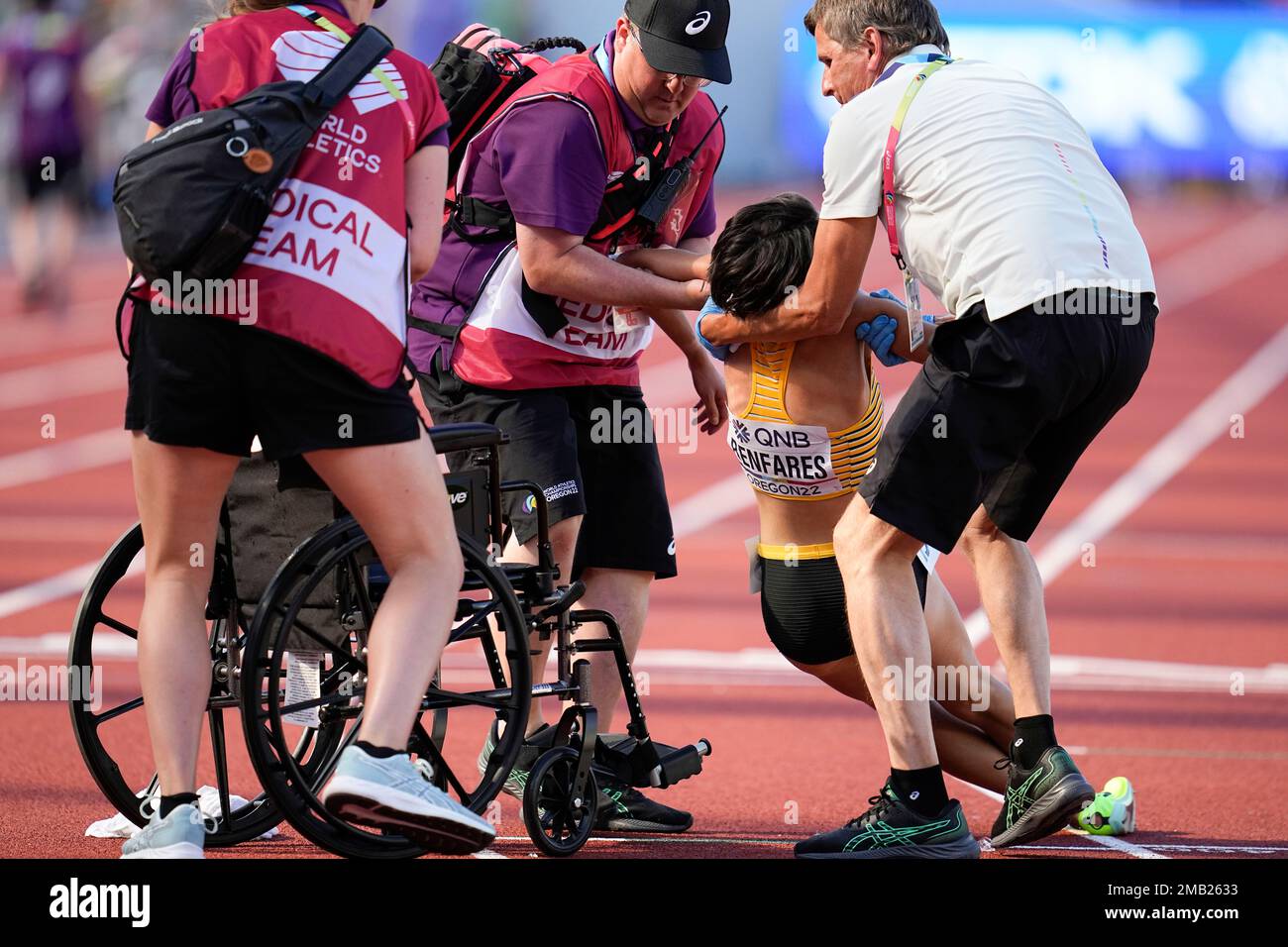 Sara Benfares, of Germany, is helped off the track after a heat in the ...