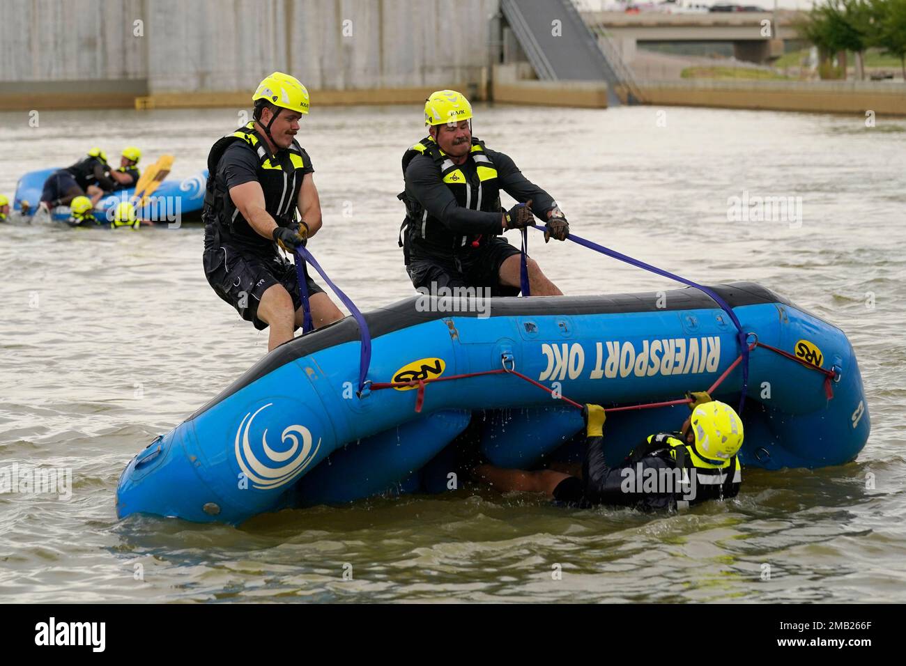 Oklahoma City firefighters right a capsized boat as they train in a ...