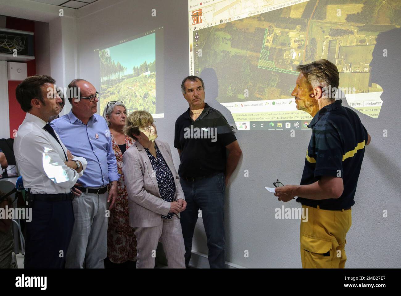 French President Emmanuel Macron, left, looks at a map as he visits at ...
