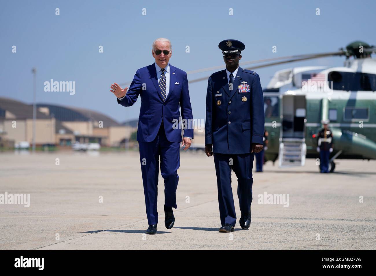 President Joe Biden waves as he walks to board Air Force One for a trip ...