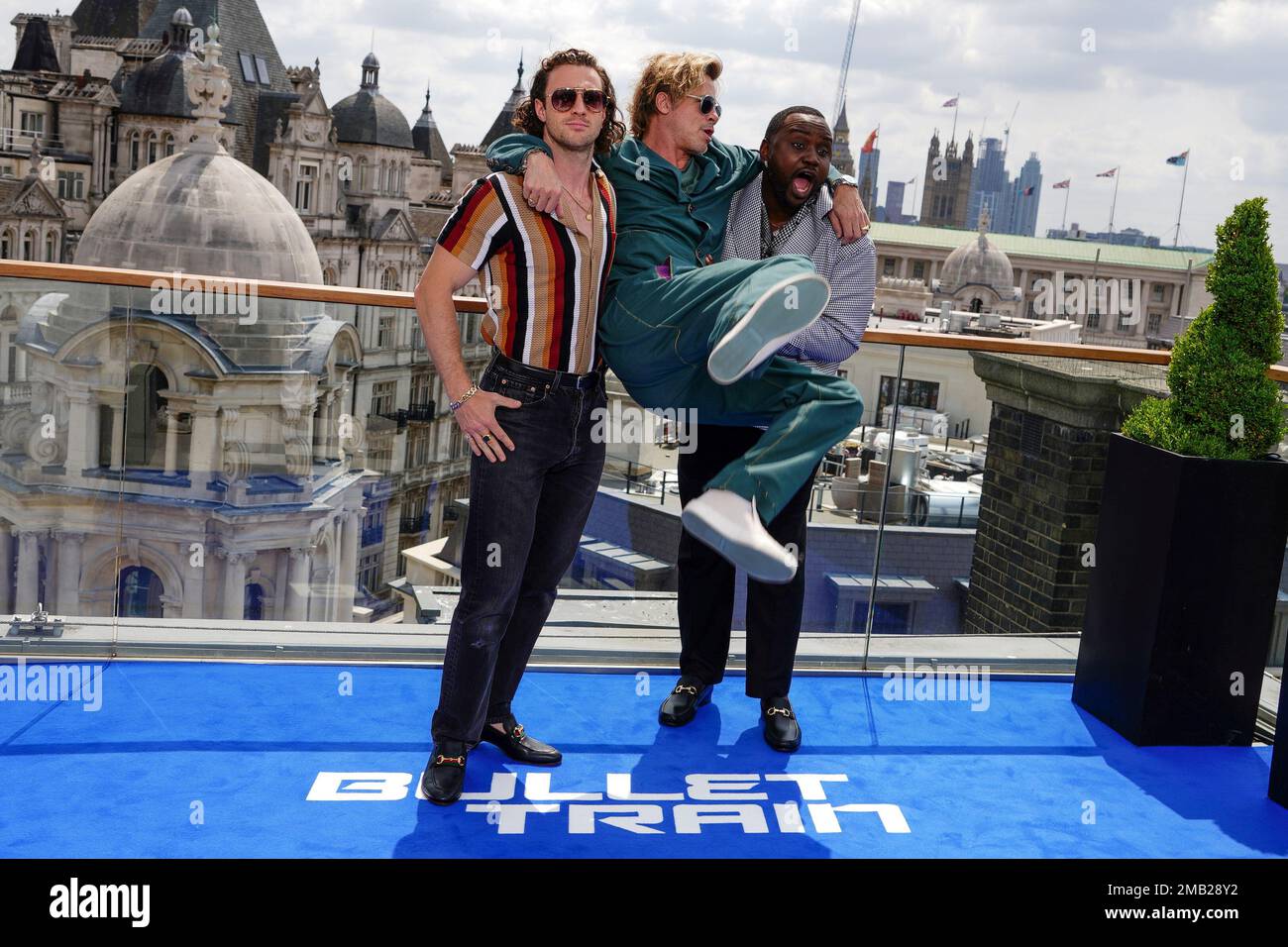 Aaron Taylor-Johnson, from left, Brad Pitt, and Brian Tyree Henry pose ...