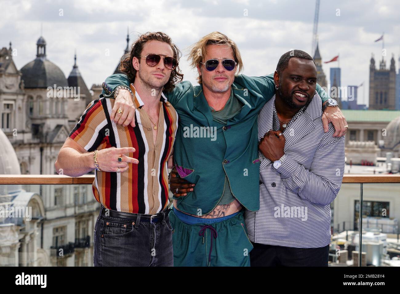 Aaron Taylor-Johnson, from left, Brad Pitt, and Brian Tyree Henry pose ...