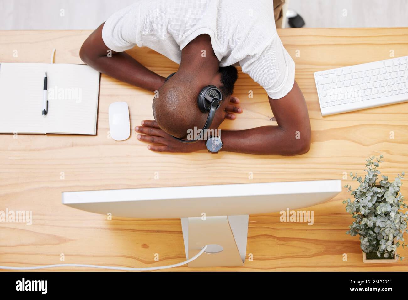 Being a human being is tiring. a young businessman taking a nap at his ...