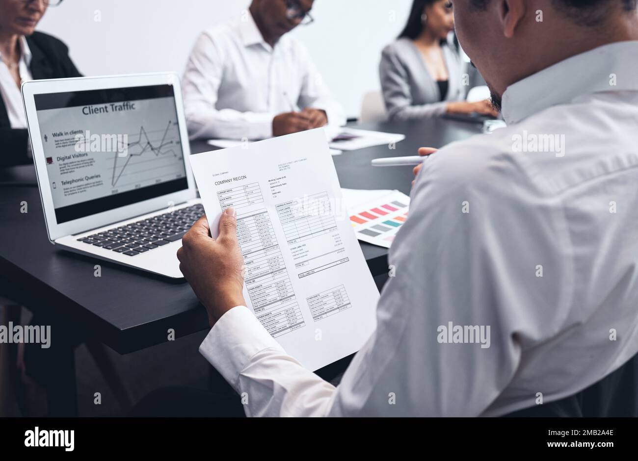 These are not adding up. a businessman checking paperwork at his desk ...