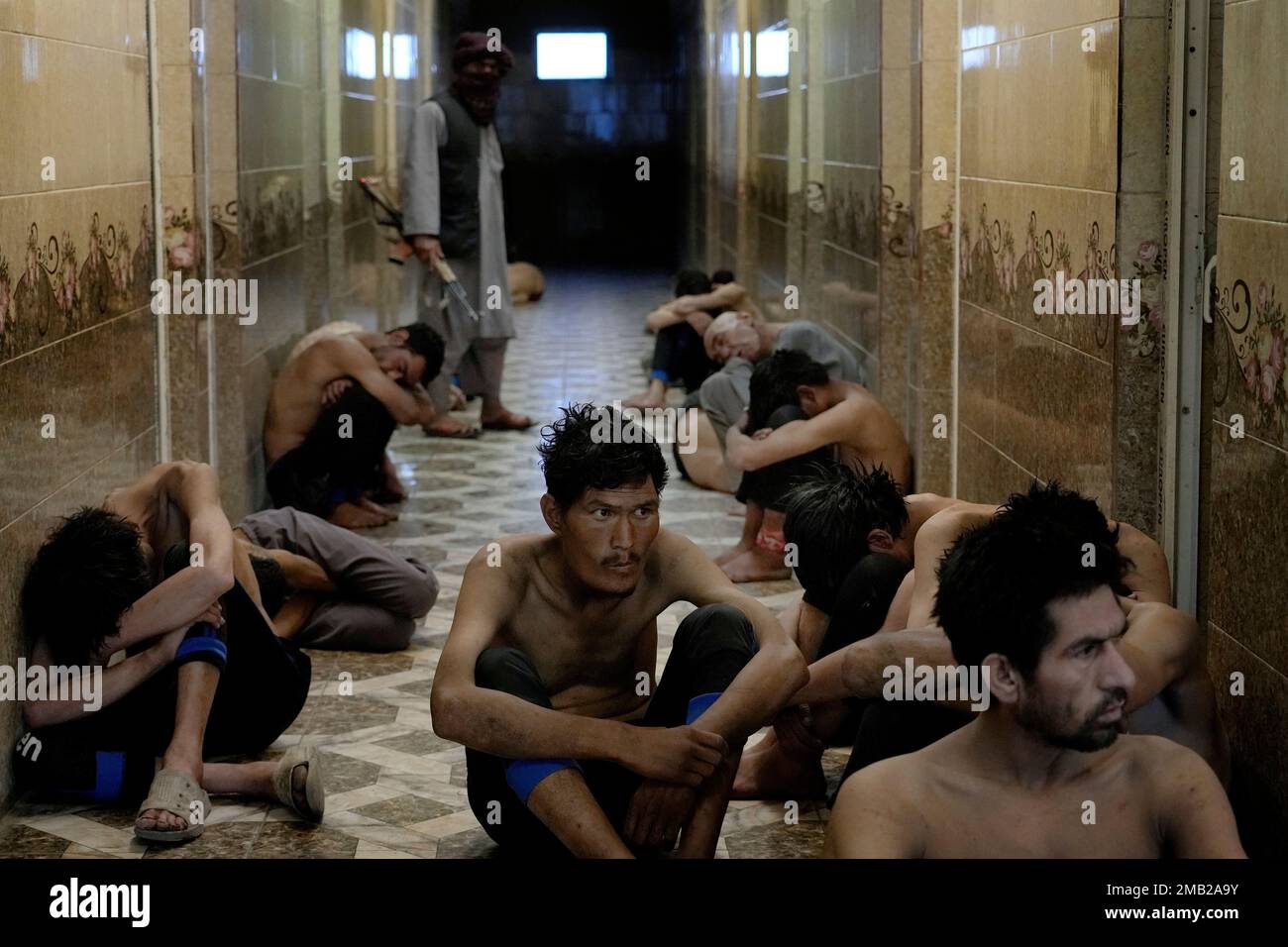 Drug addicts detained during a Taliban raid wait to have a shower in a ...