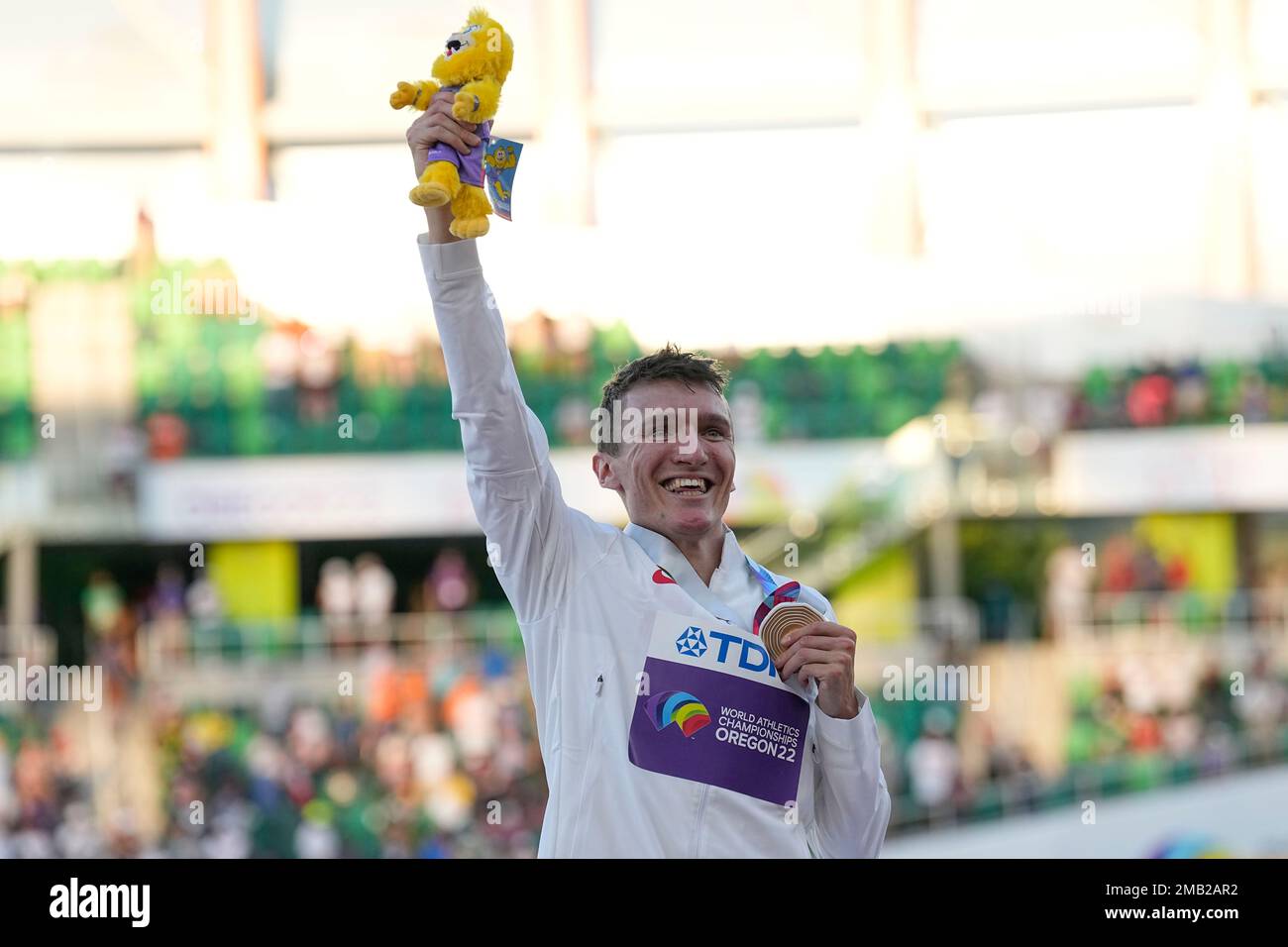 Gold medalist Jake Wightman, of Britain, poses on the podium after the ...