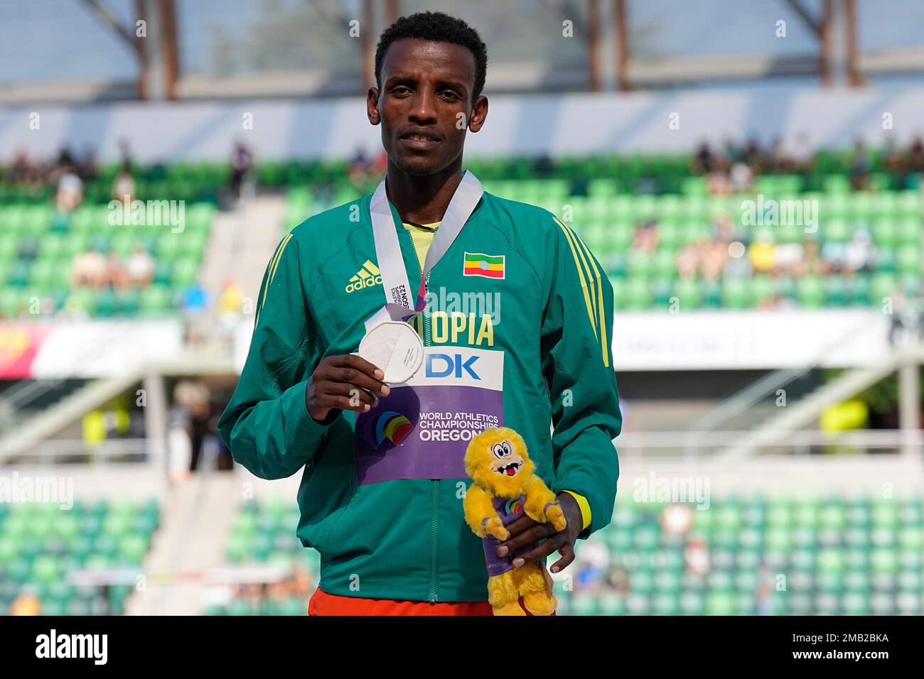 Silver medalist Lamecha Girma, of Ethiopia, left, stands during a medal ...