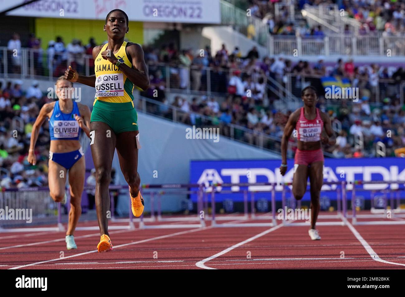 Janieve Russell, of Jamaica, wins a heat during the women's 400-meter ...